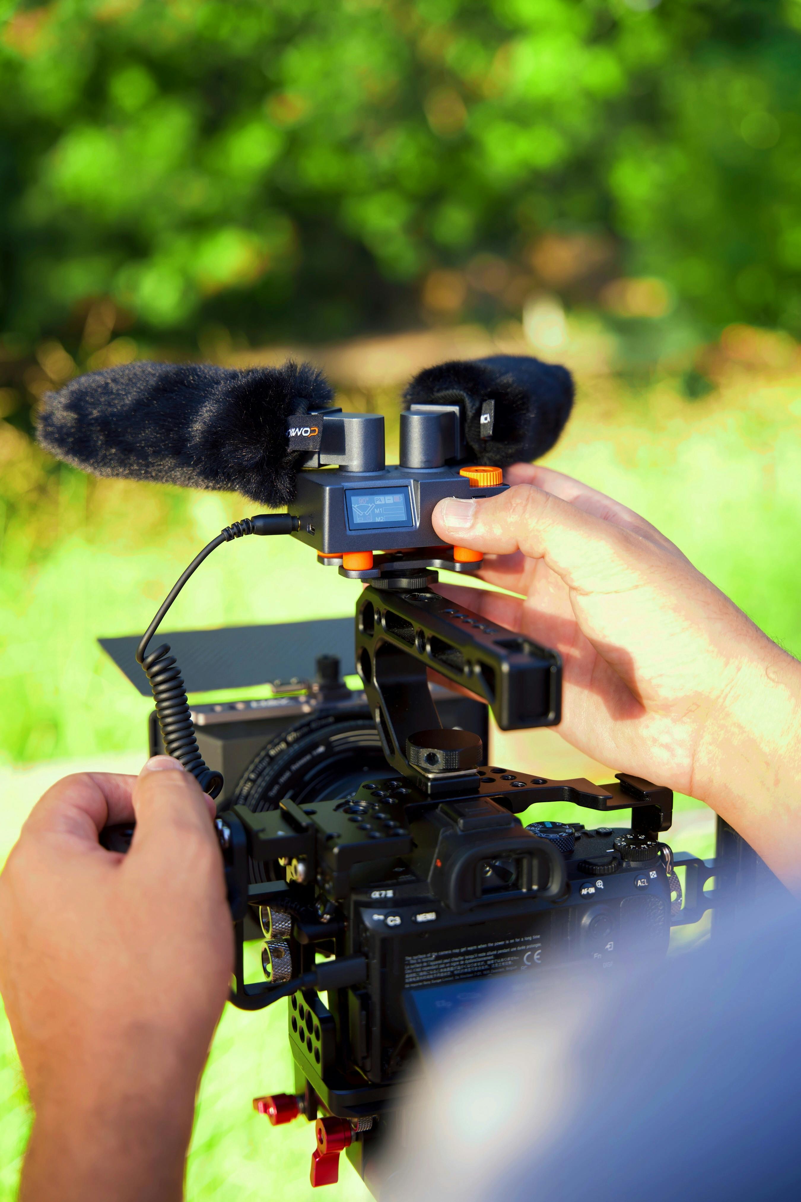 Camera Operator Using a Video Camera · Free Stock Photo