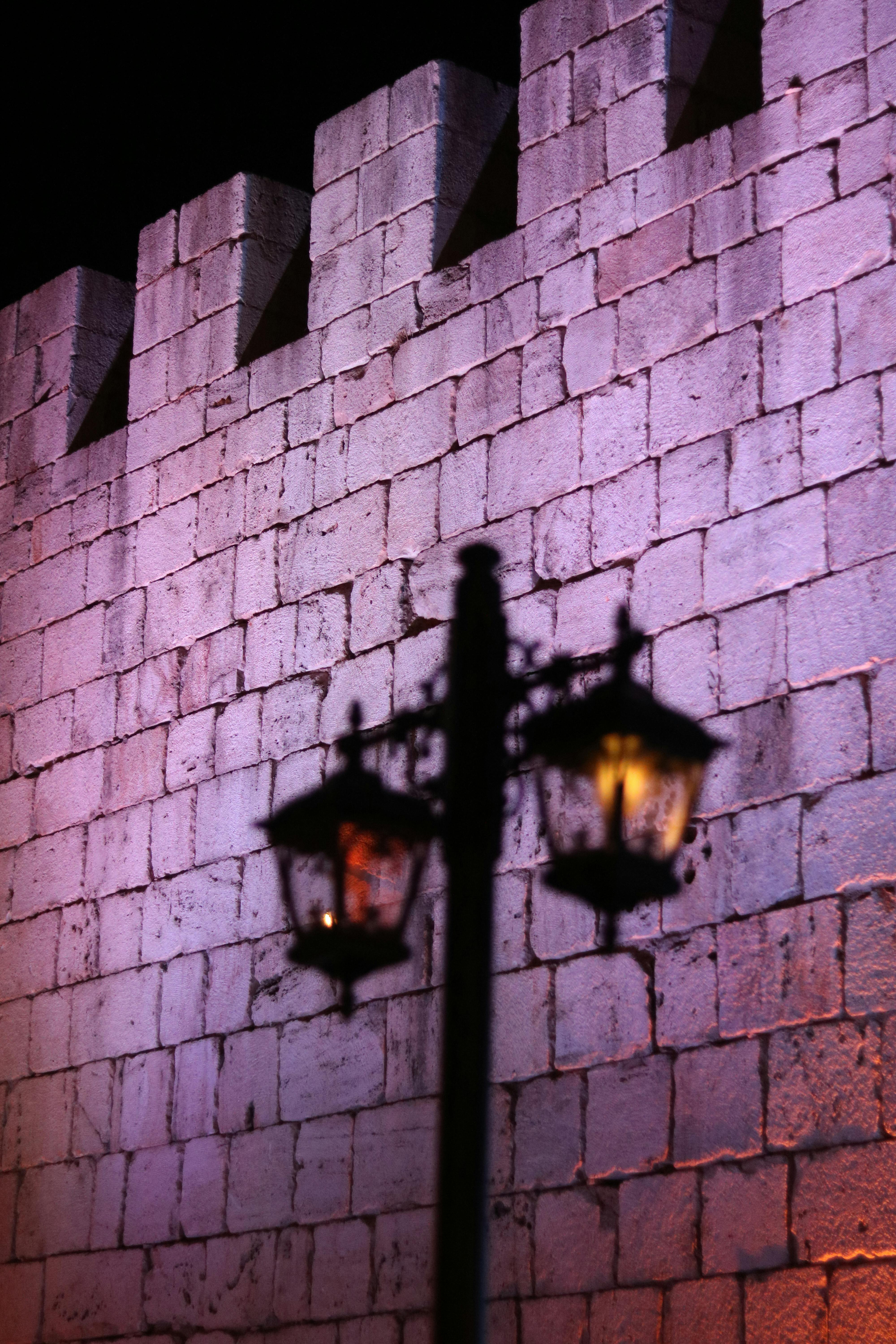 Light on Fortification Wall behind Street Lamp · Free Stock Photo