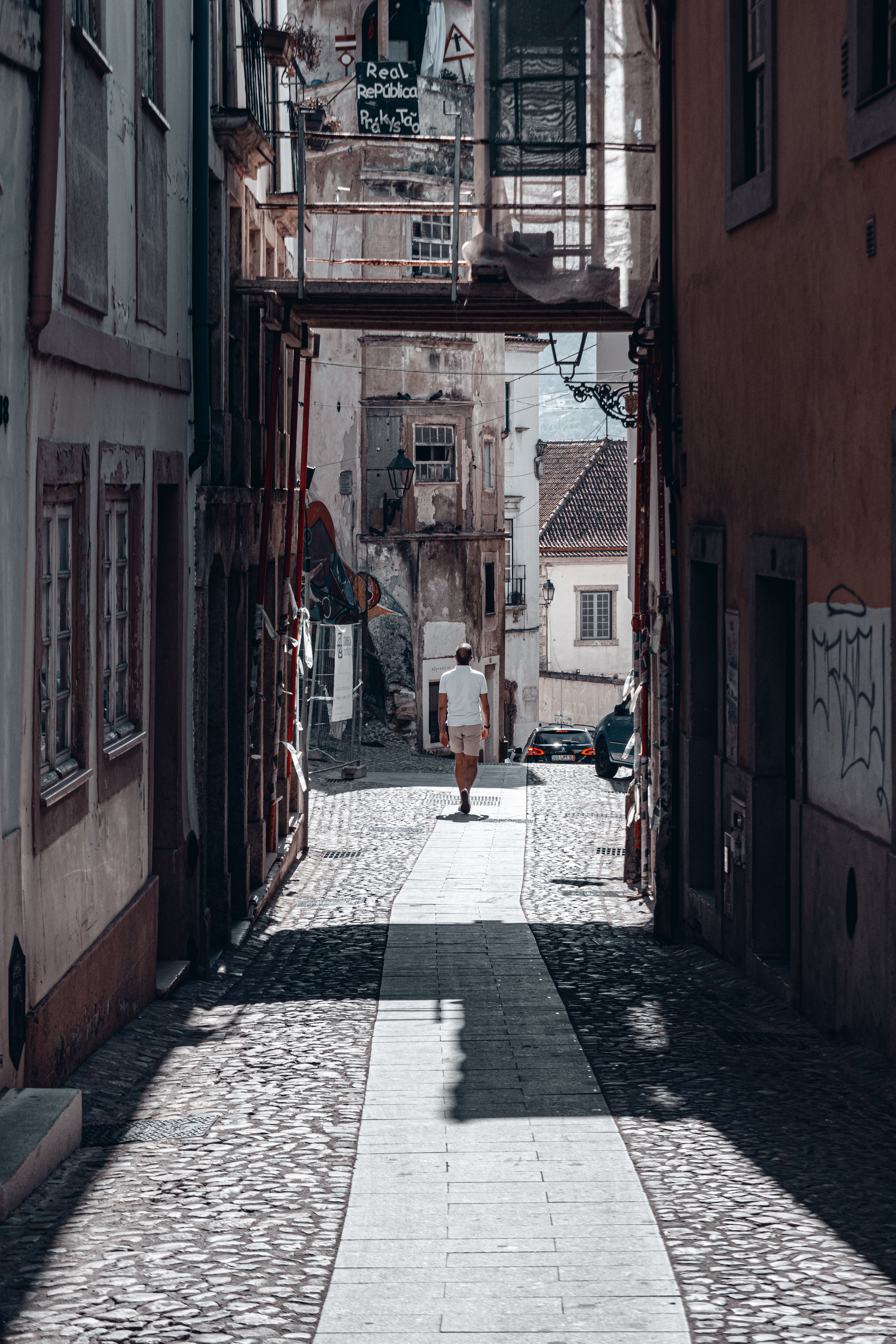 Man Walking Along an Alley · Free Stock Photo