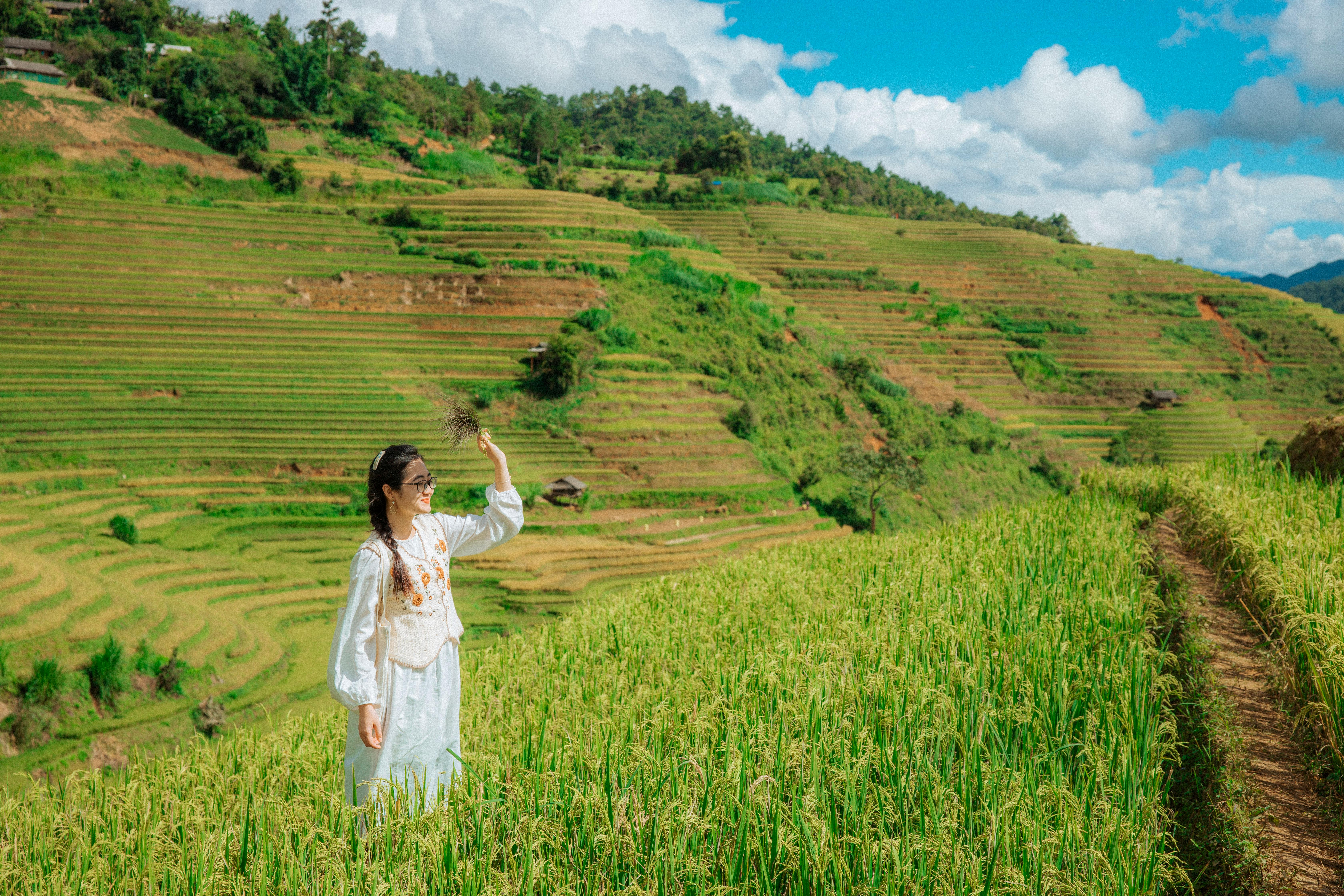 Woman in Traditional Dress Standing on Rural Field · Free Stock Photo