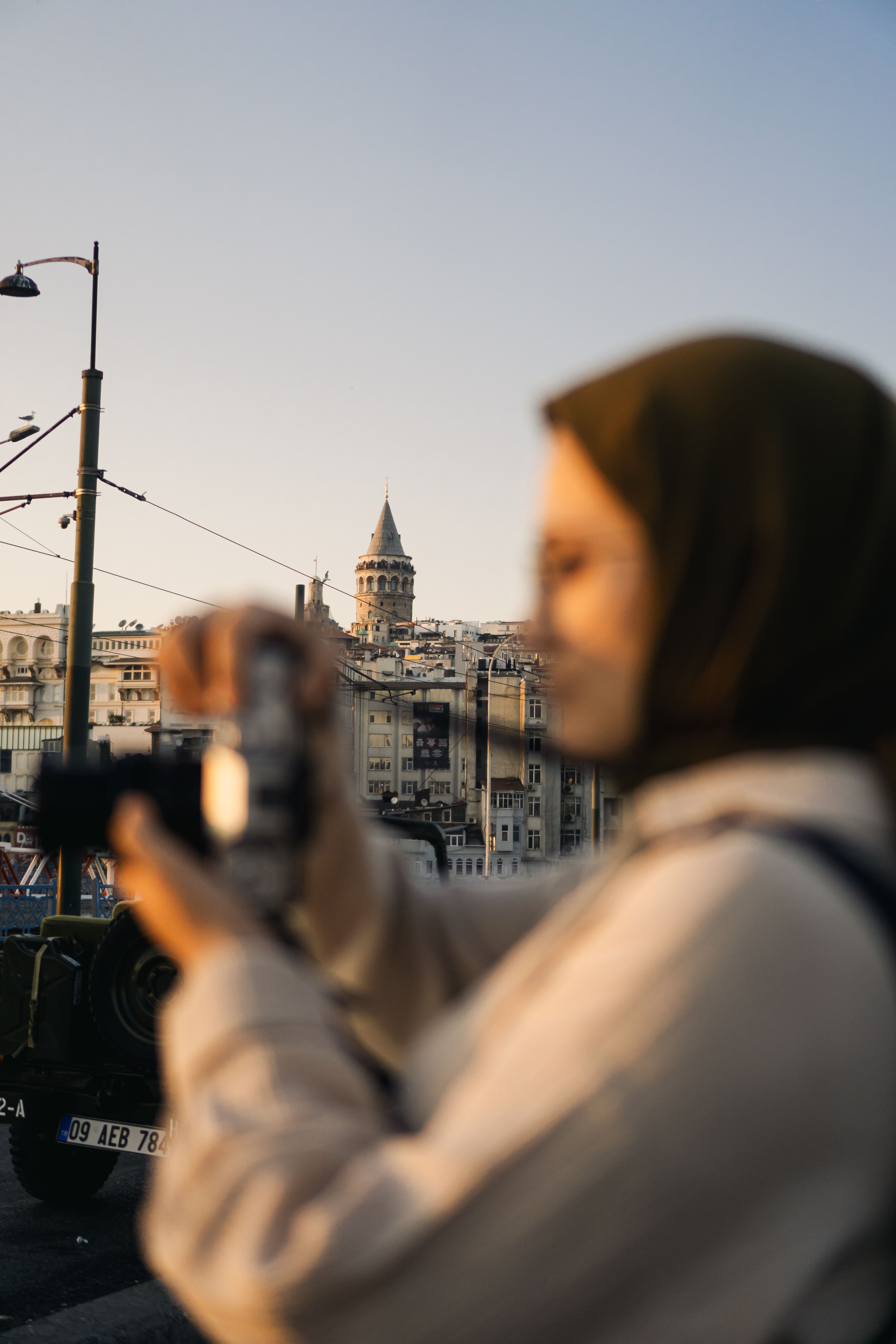 Galata Tower behind Woman in Hjiab Taking Pictures with Camera · Free ...