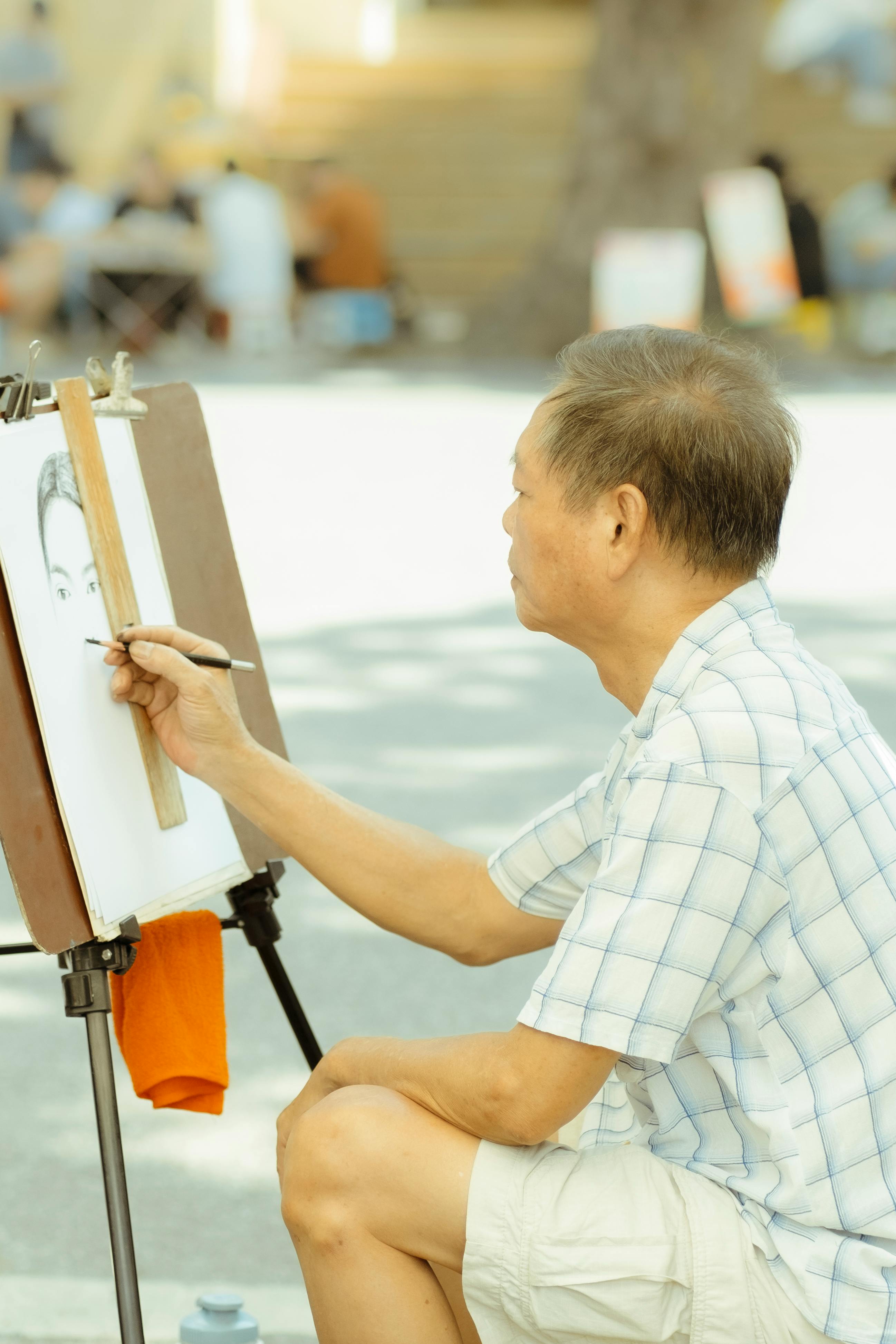 A Man Drawing Portraits on a Street · Free Stock Photo