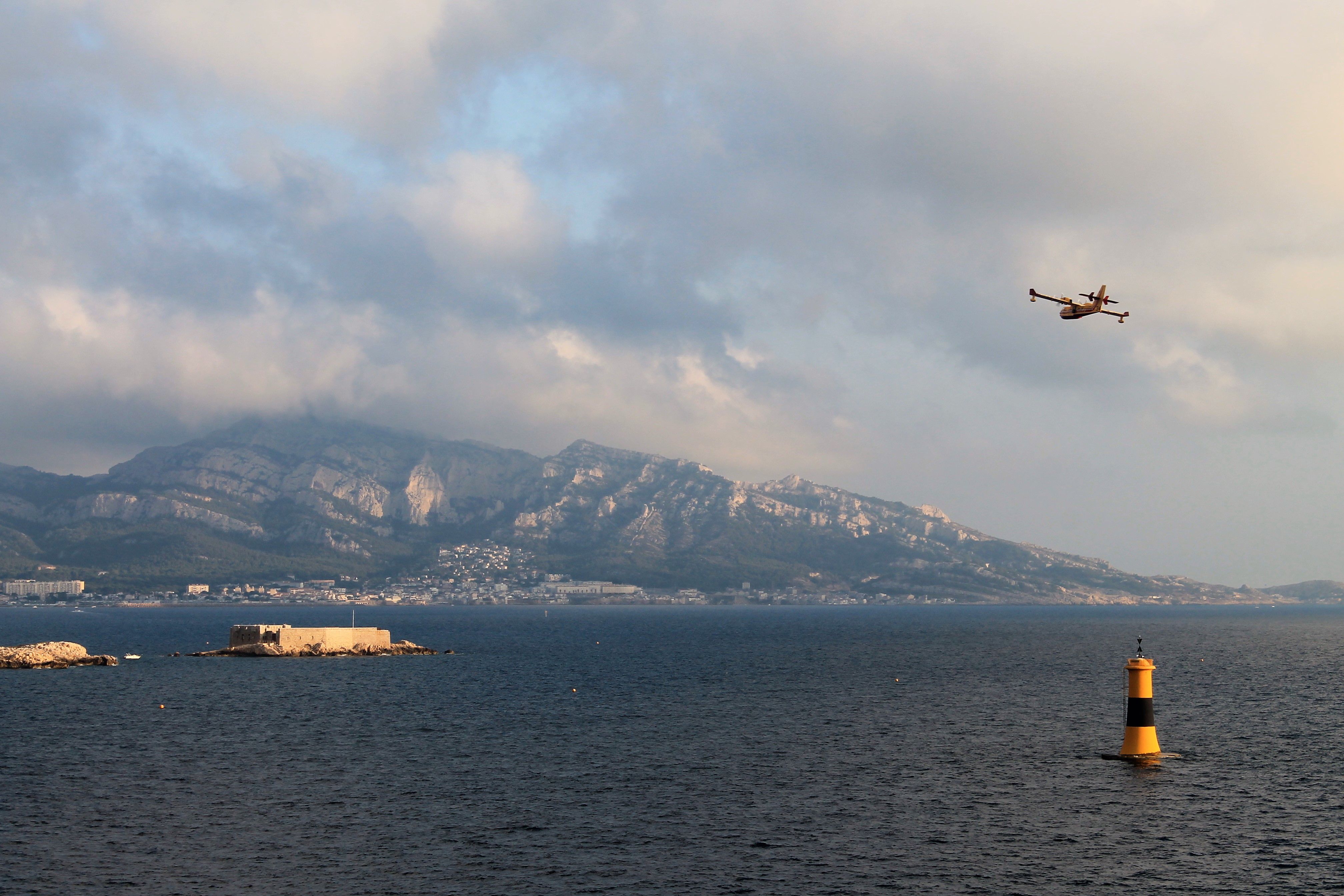 Airplane Flying above Sea near Mountains · Free Stock Photo
