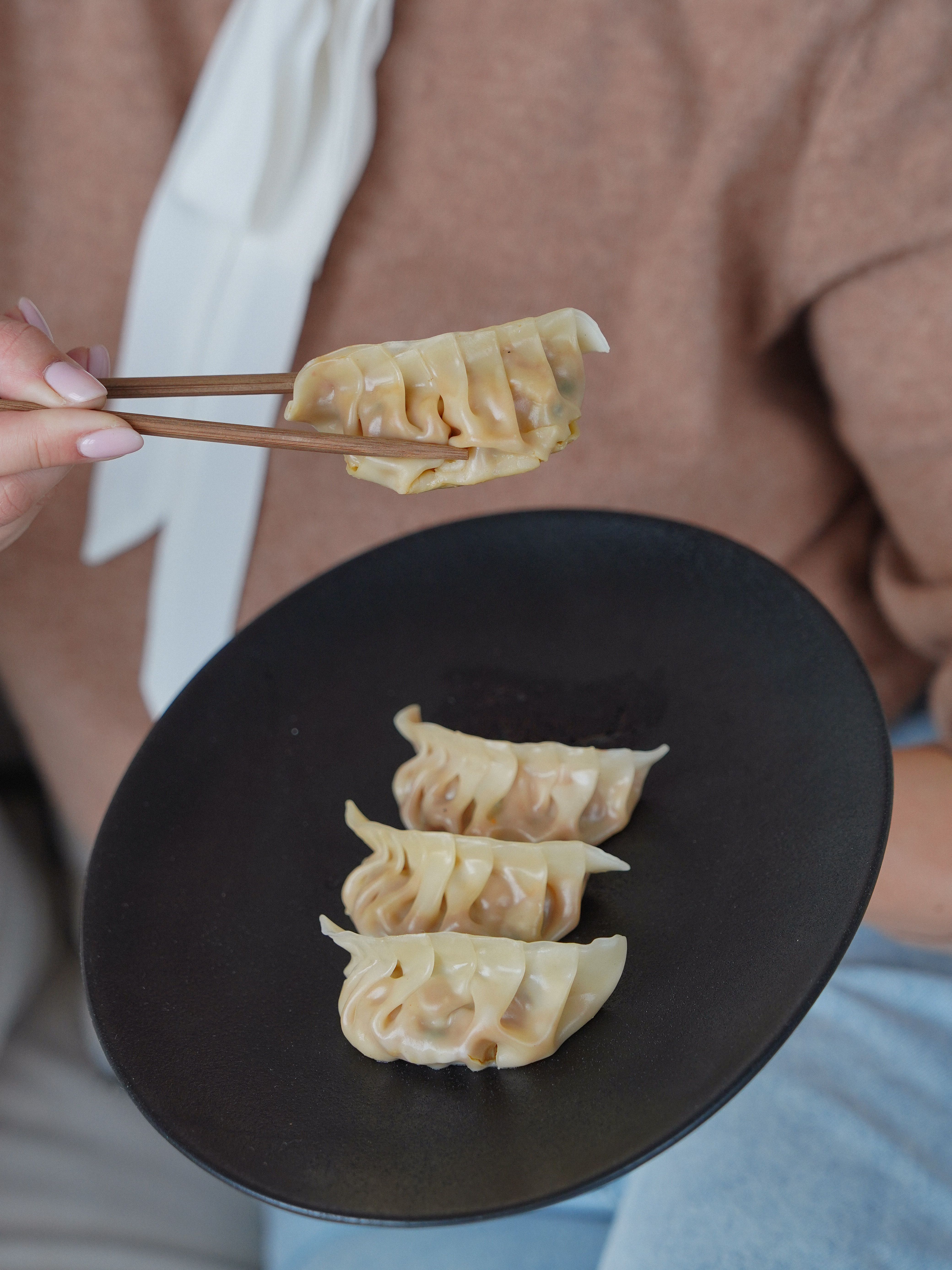 Woman Holding Dumplings with Chopsticks · Free Stock Photo