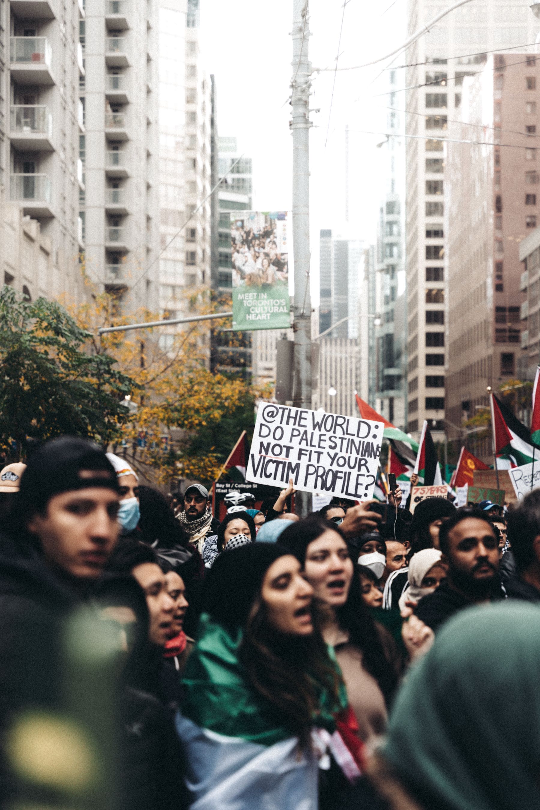 A group of people holding signs in the street · Free Stock Photo