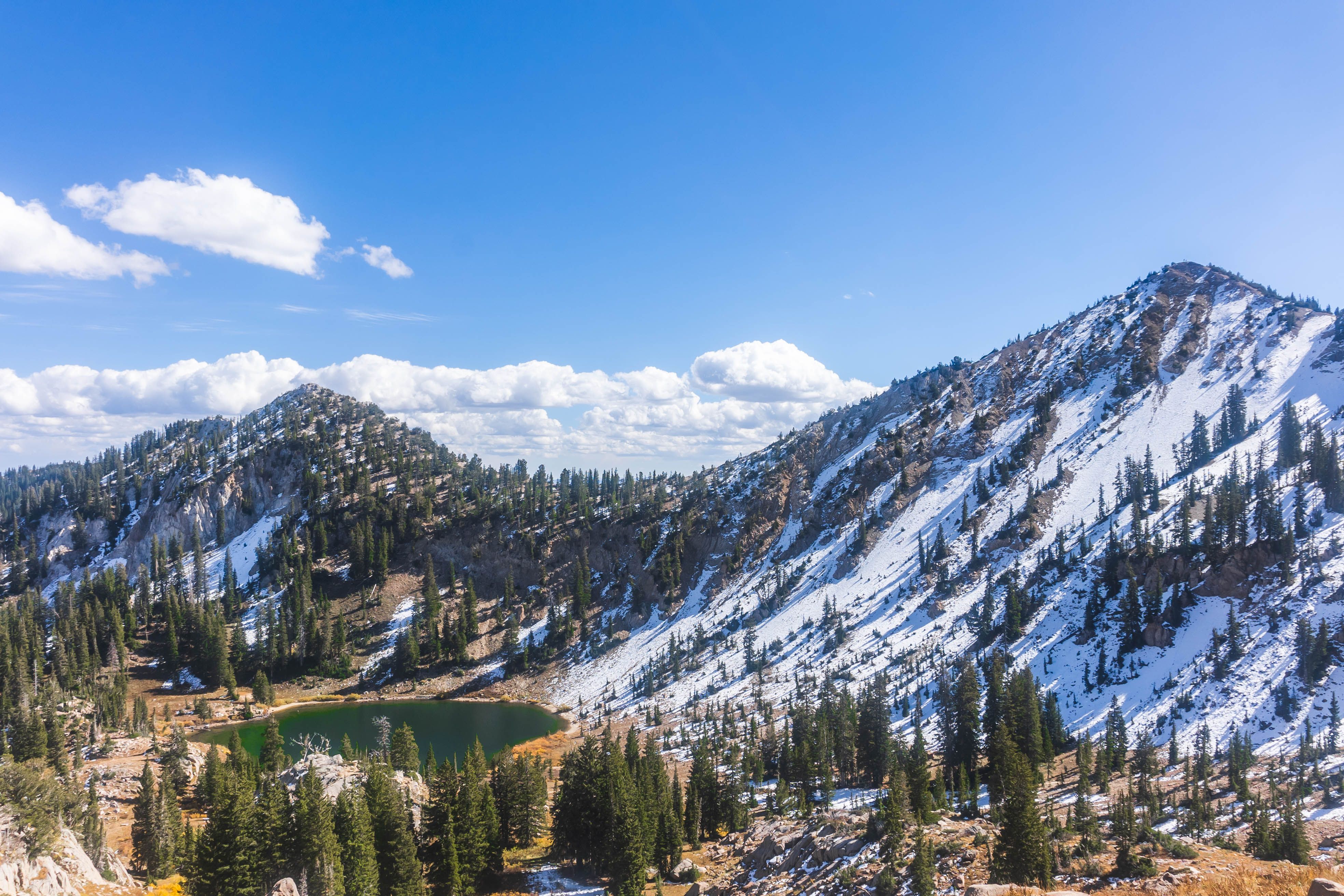 Snow Covered Mountain Range Among Clouds and Steam · Free Stock Photo
