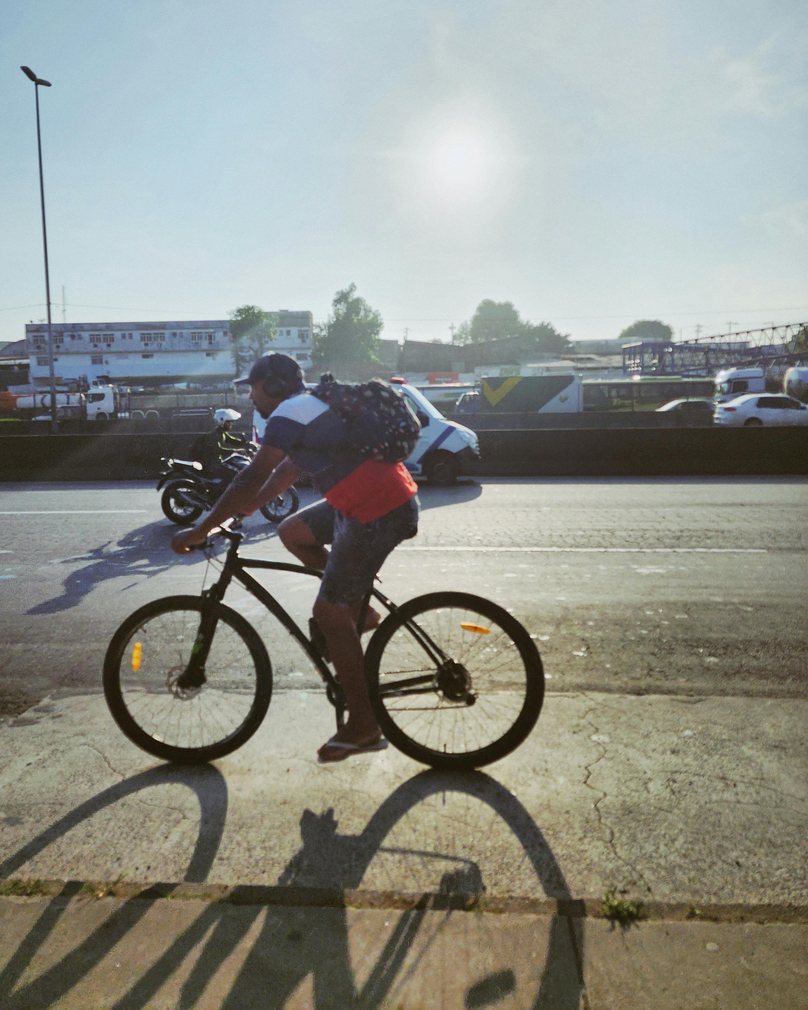 Man Riding on Bicycle on City Street · Free Stock Photo