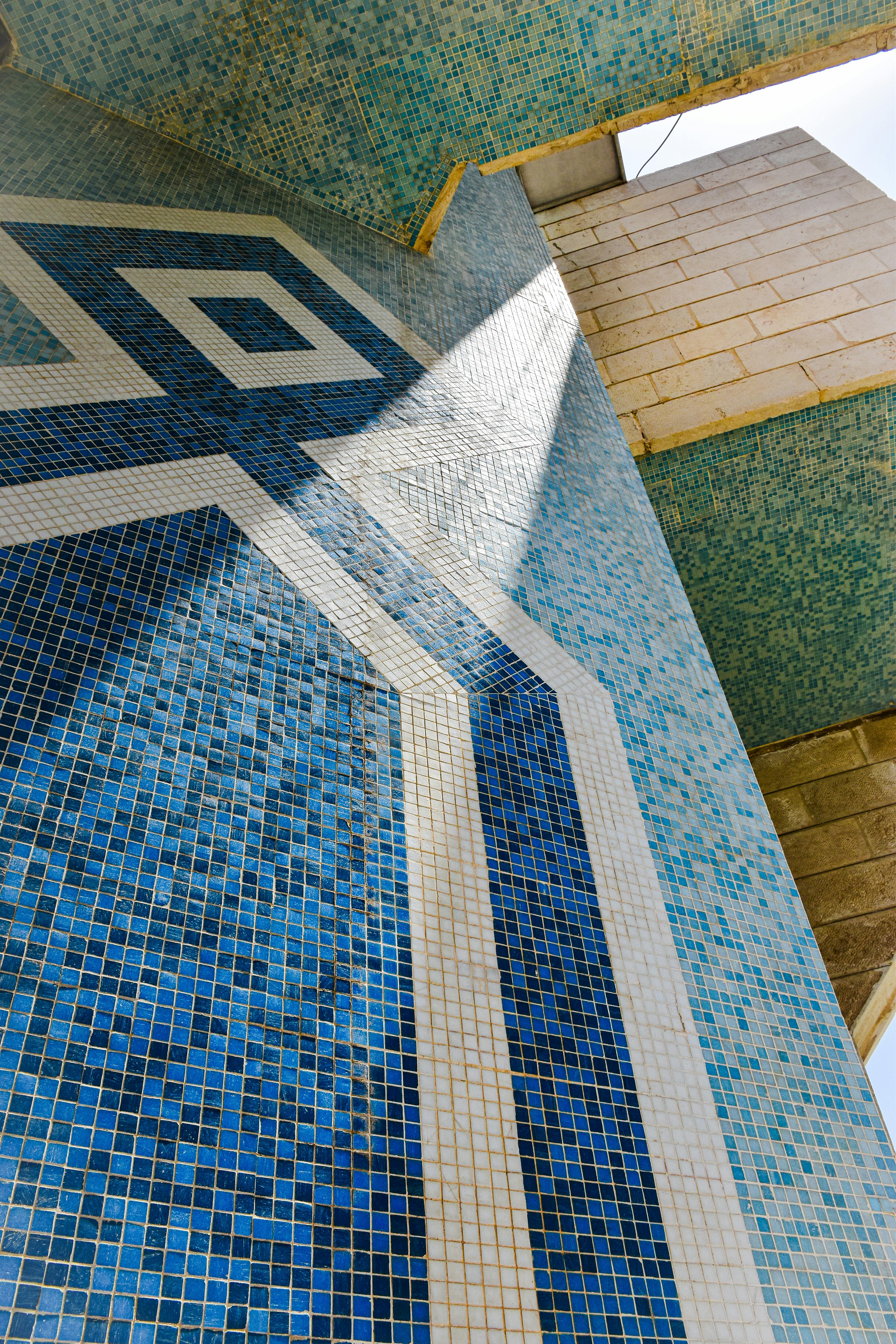 A blue and white mosaic tile on the wall · Free Stock Photo