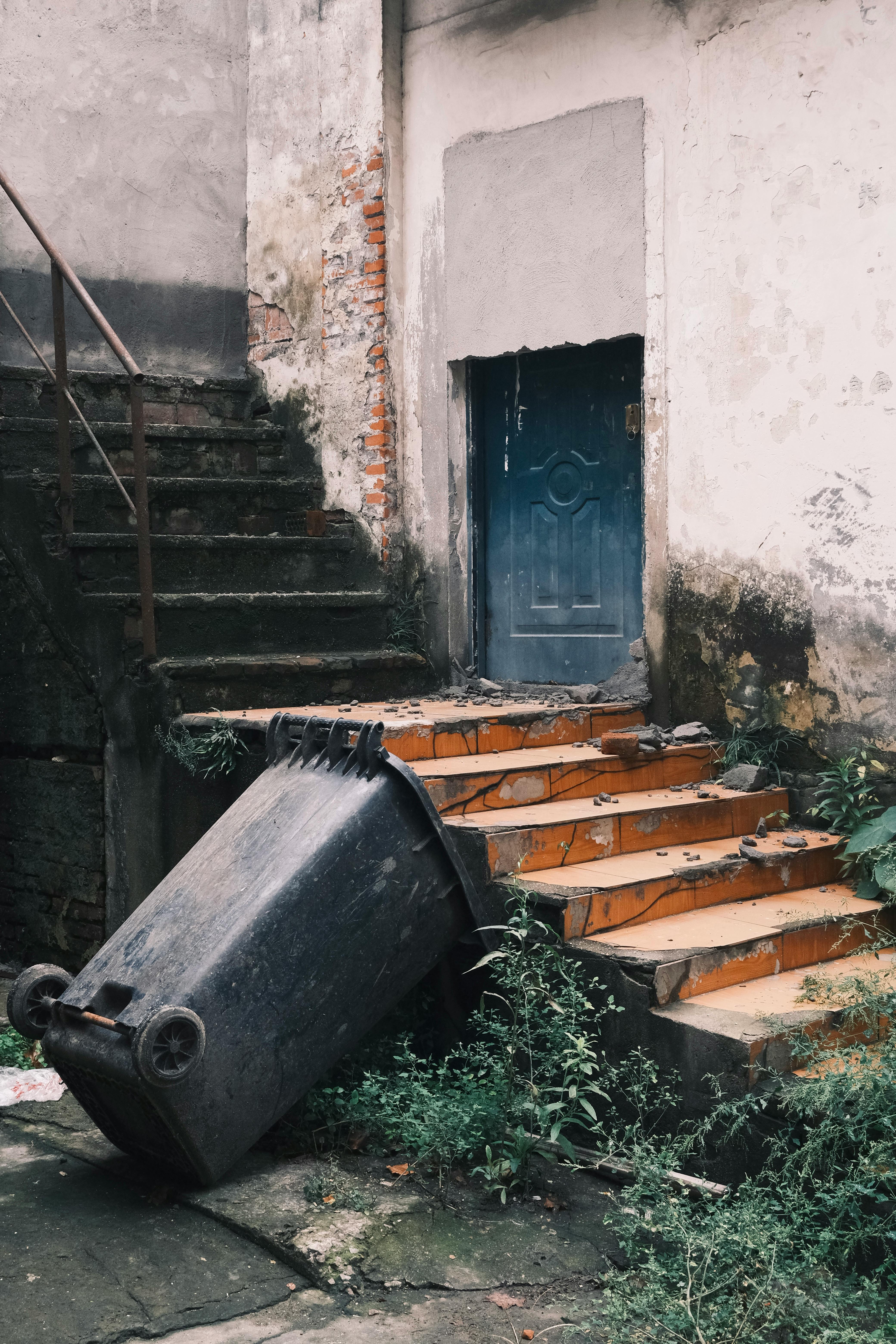 Garbage Bin Lying Down near Stairs · Free Stock Photo