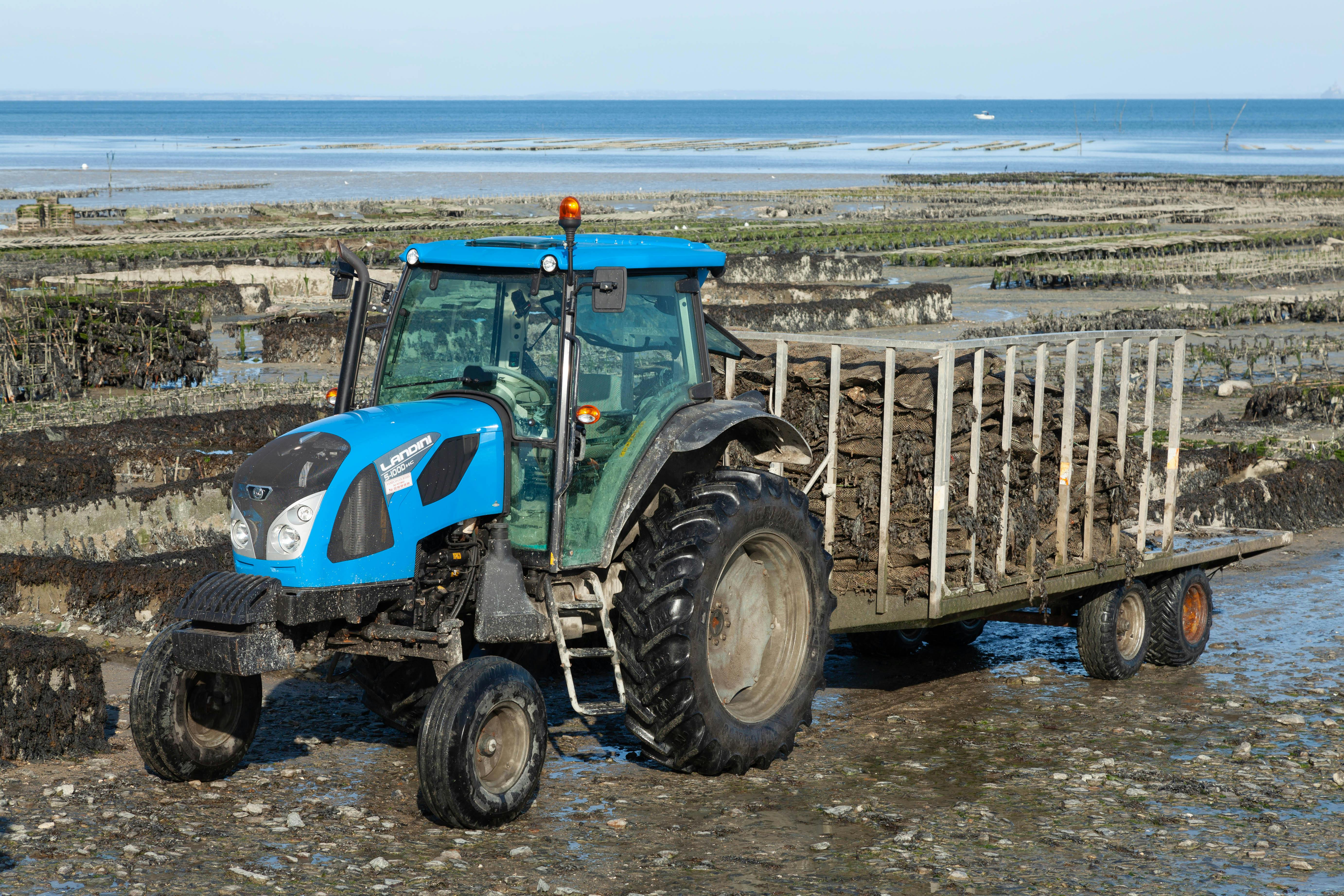 Tractor with Trailer on Sea Shore · Free Stock Photo