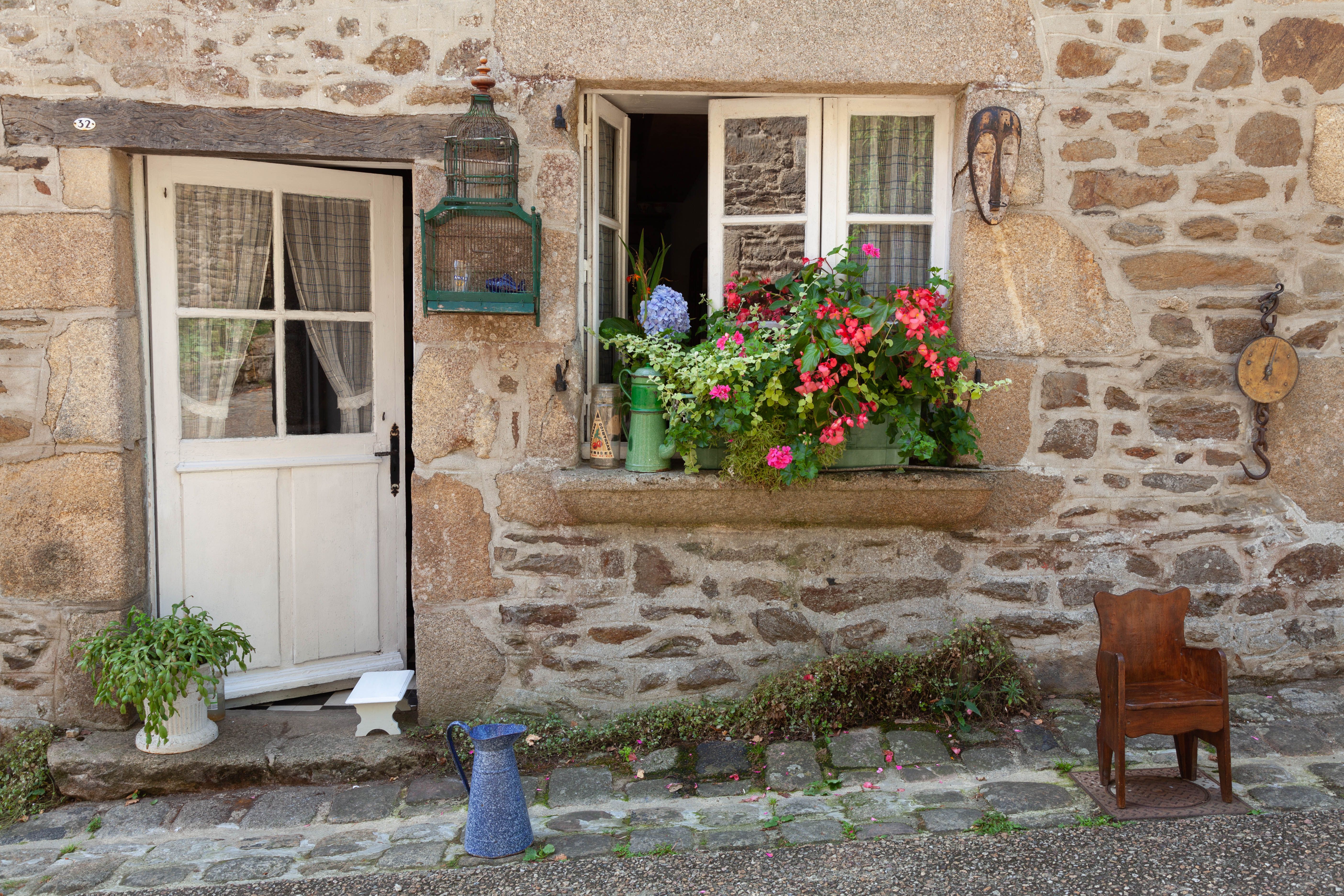 Shabby house window decorated with potted plants · Free Stock Photo