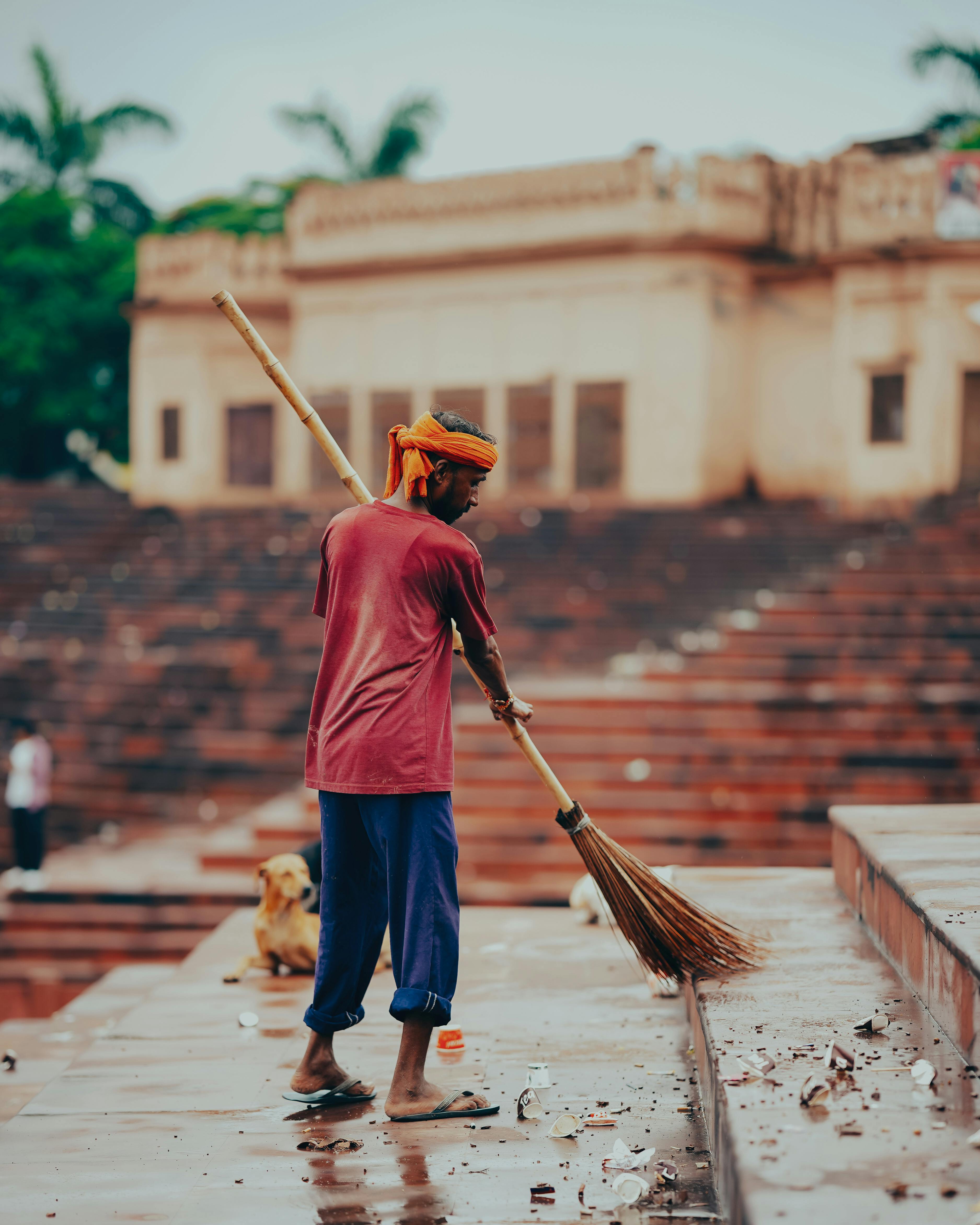 A Man Sweeping the Pavement · Free Stock Photo
