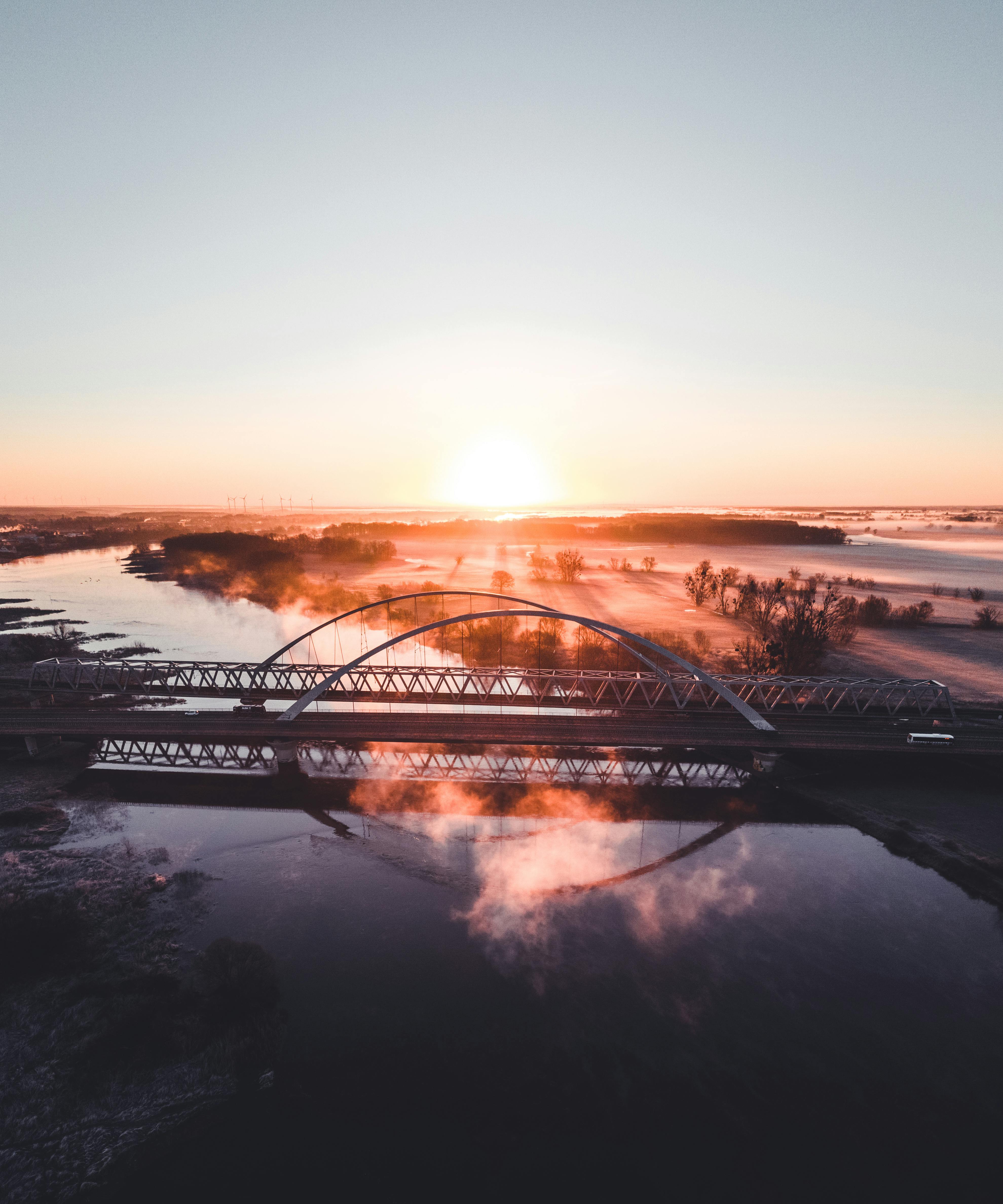 Sunset Sunlight over Bridge on River on Plains · Free Stock Photo