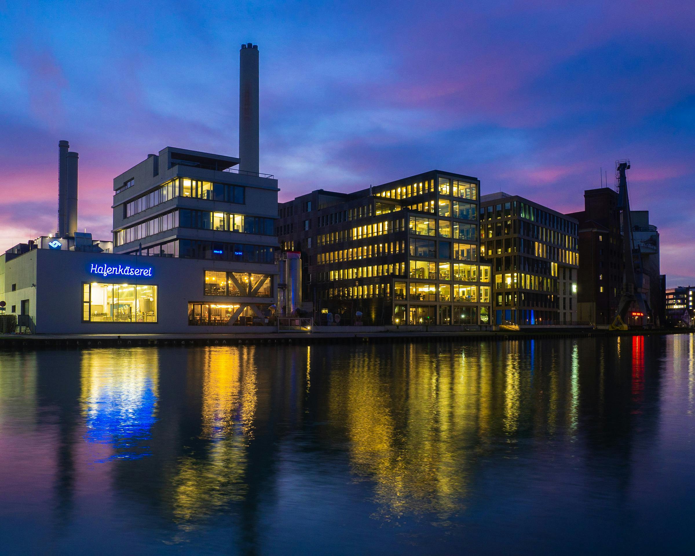 Lighted Buildings during Nighttime Near Body of Water · Free Stock Photo