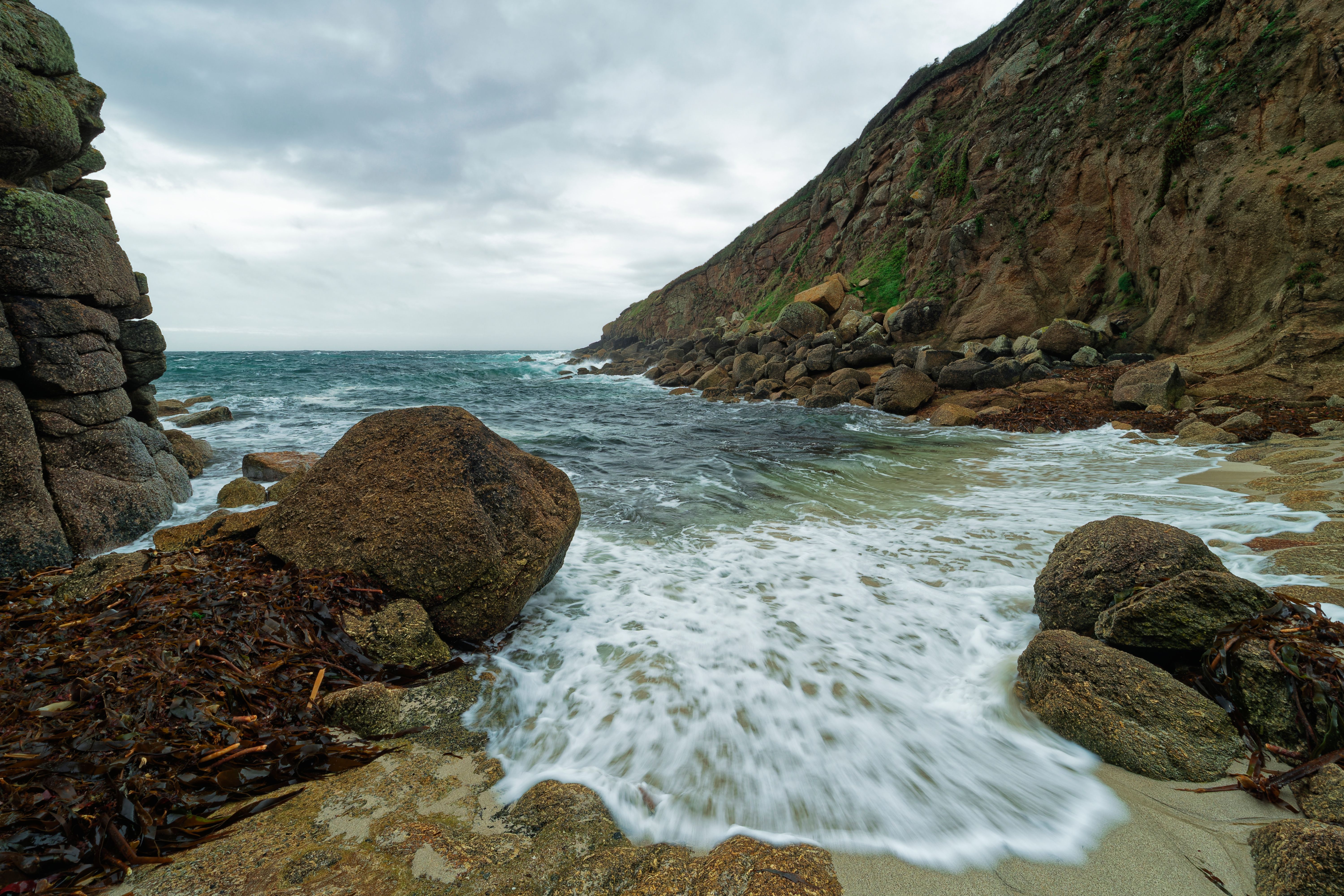 Waves Crashing onto Beach among Cliffs · Free Stock Photo