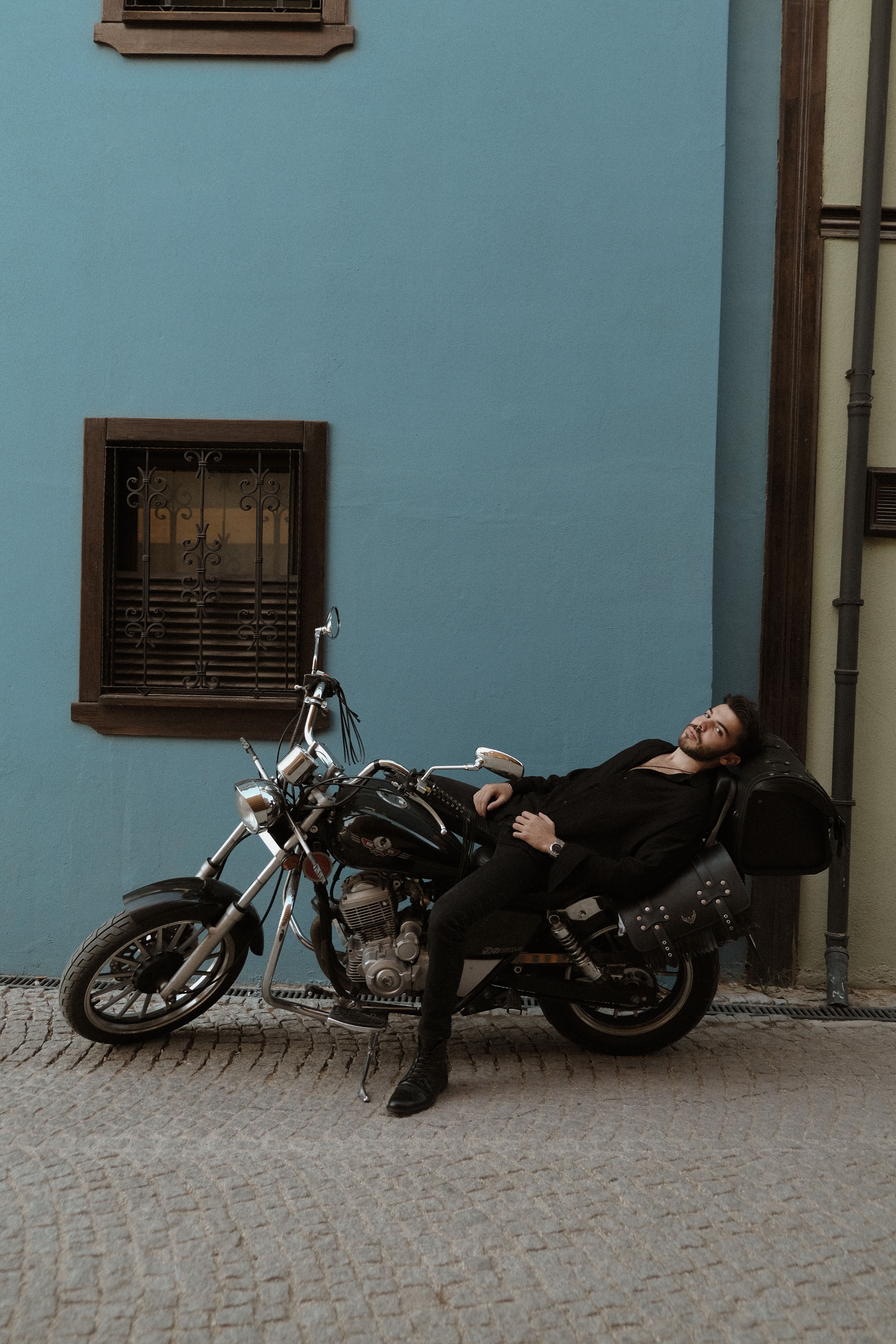 Man in Shirt Lying Down on Motorbike on Street · Free Stock Photo