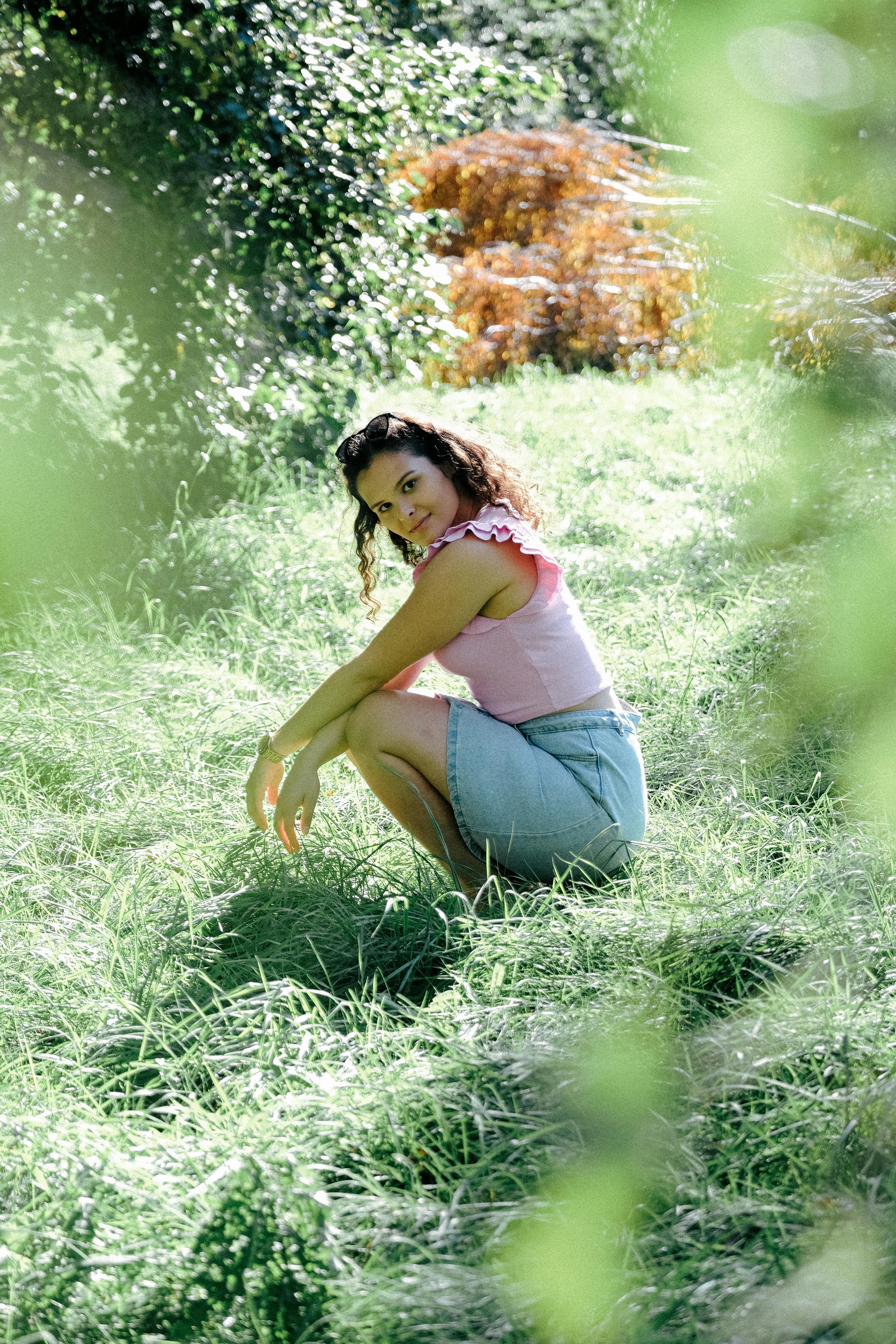 Woman Crouching in Grass · Free Stock Photo