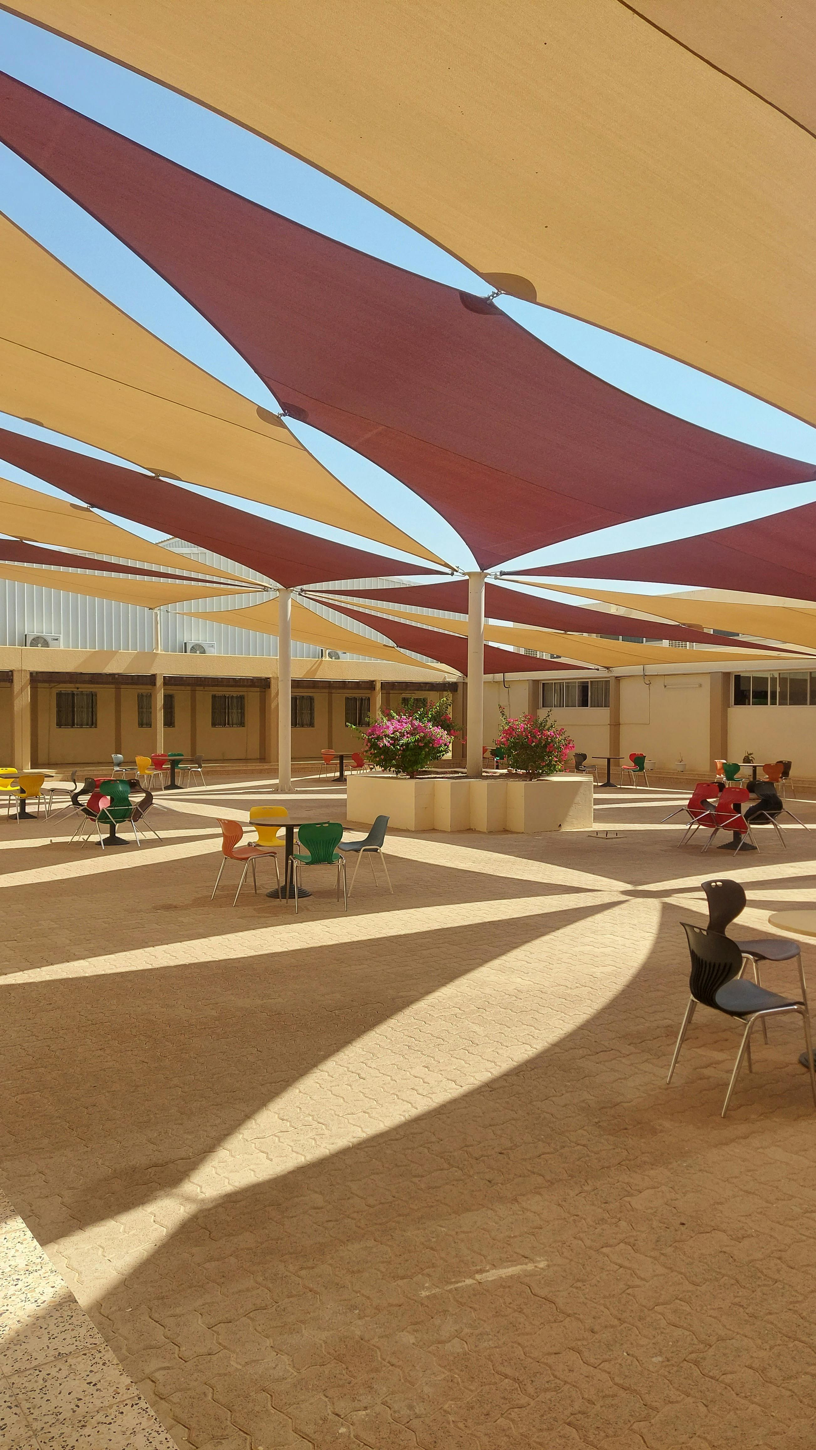 Tables and Chairs in Shadows under Covers · Free Stock Photo