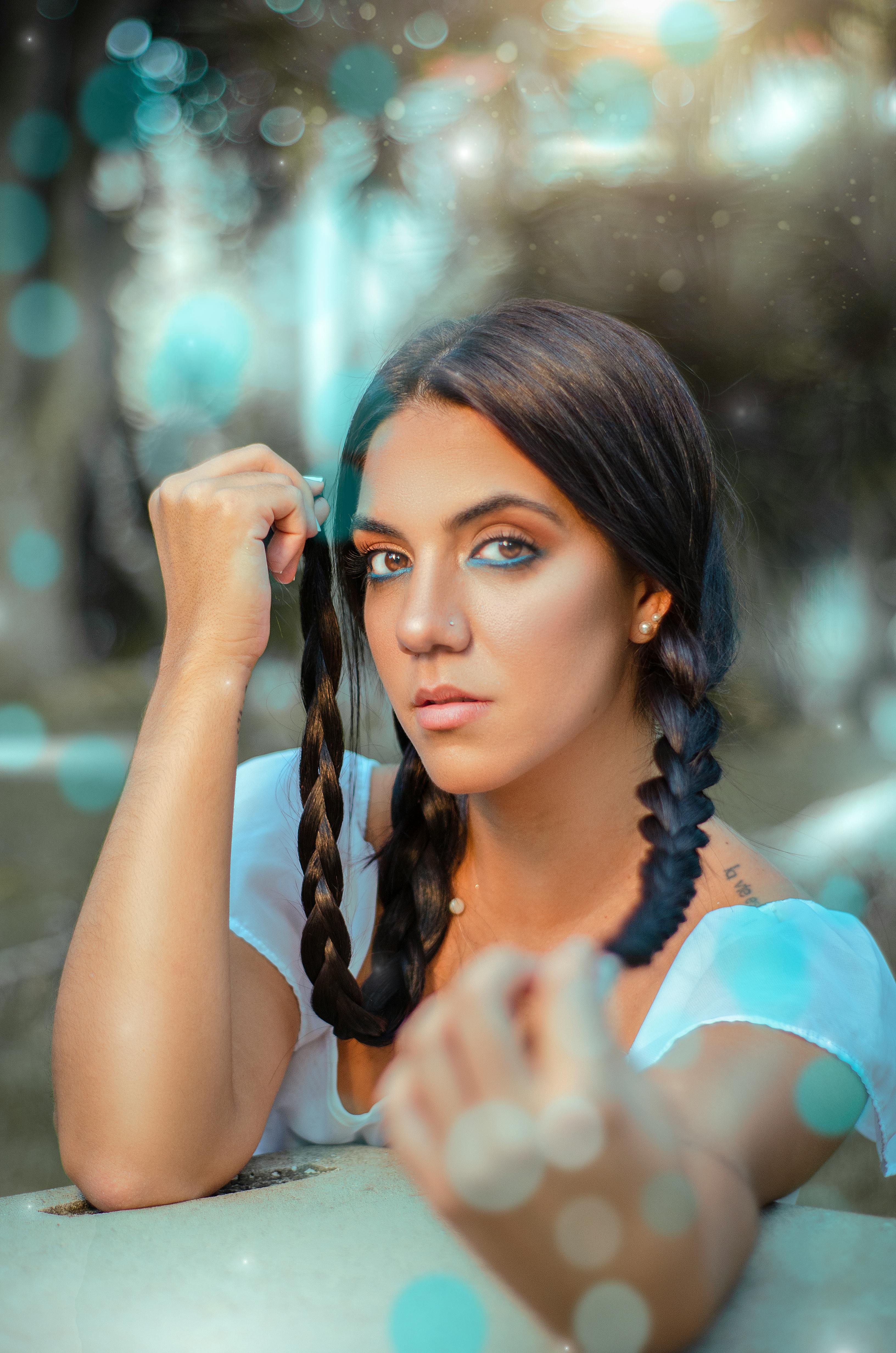 Young Woman with Braided Hair Standing Outside · Free Stock Photo