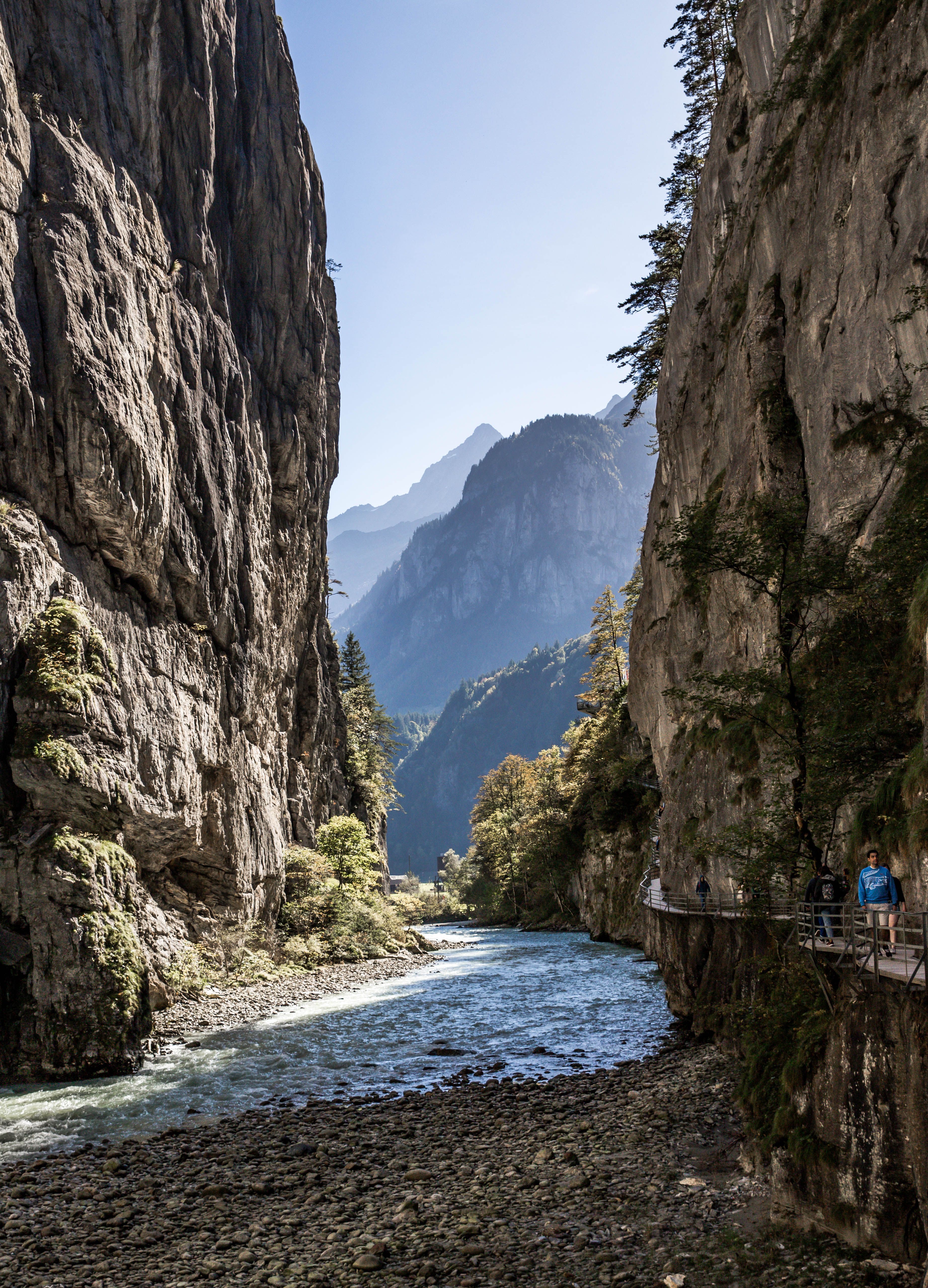 A man walking along a narrow path in a canyon · Free Stock Photo