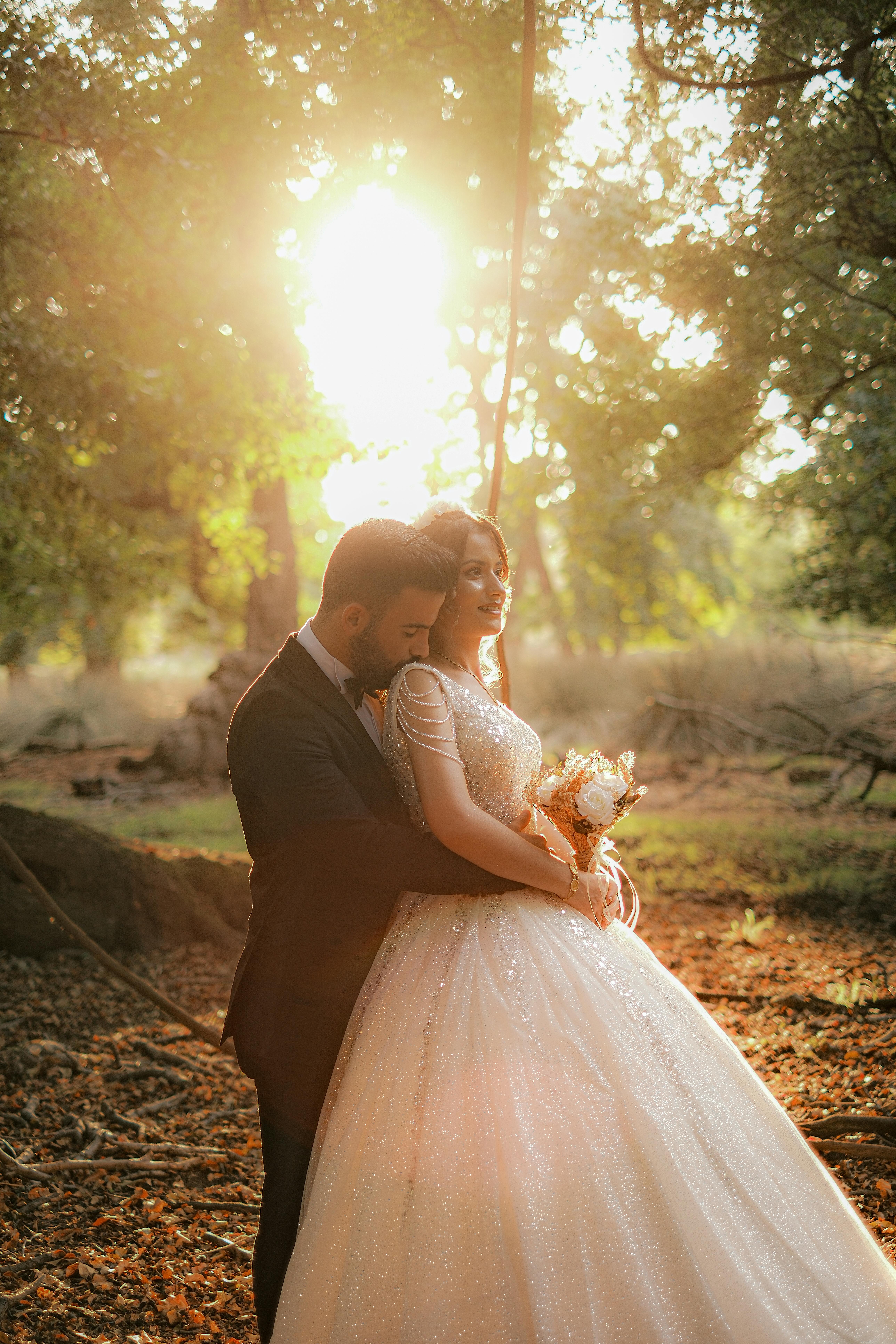 The Groom Embracing the Bride and Kissing her on the Shoulder · Free ...