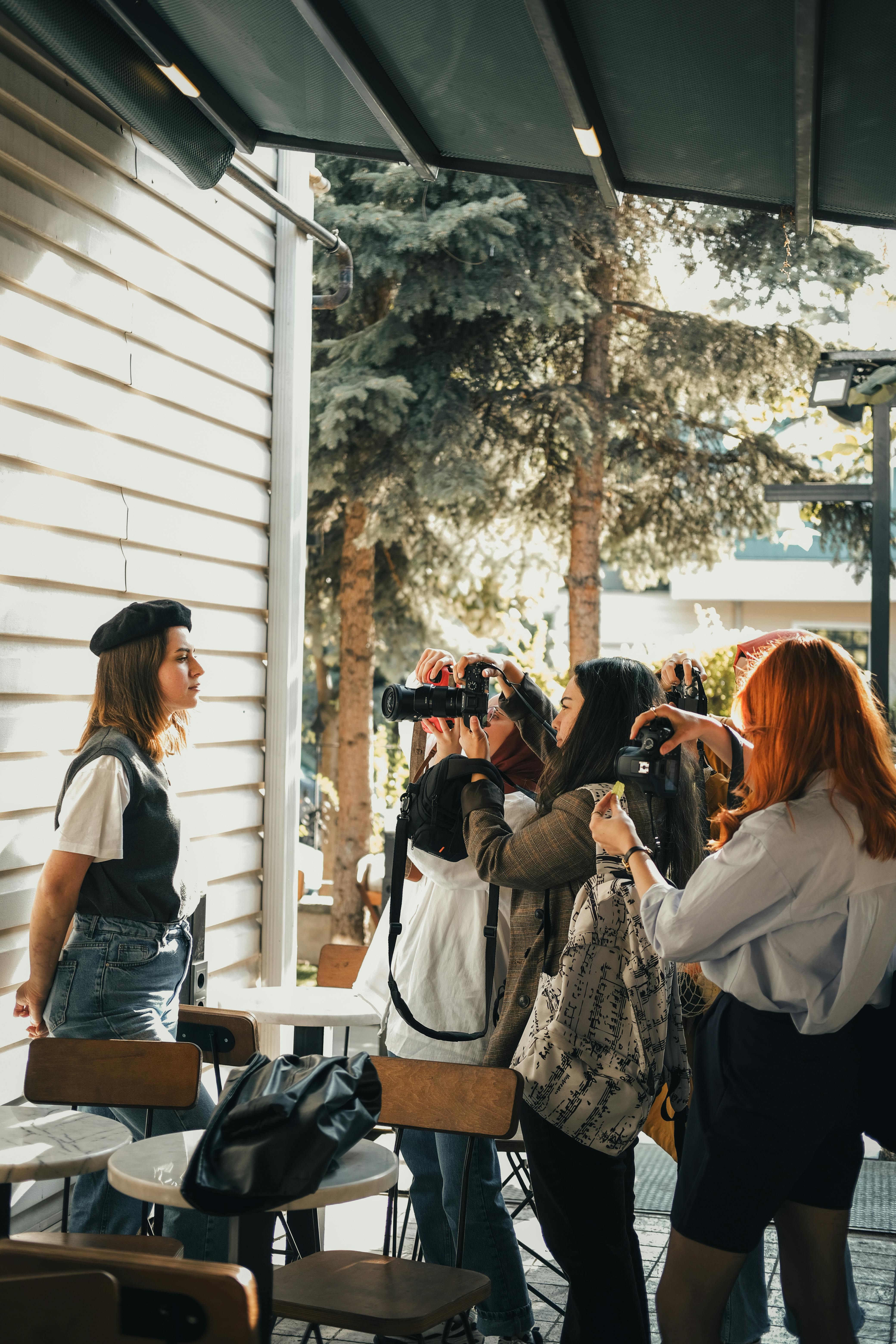 Multiple Cameras Capture Person Posing Outside a House · Free Stock Photo