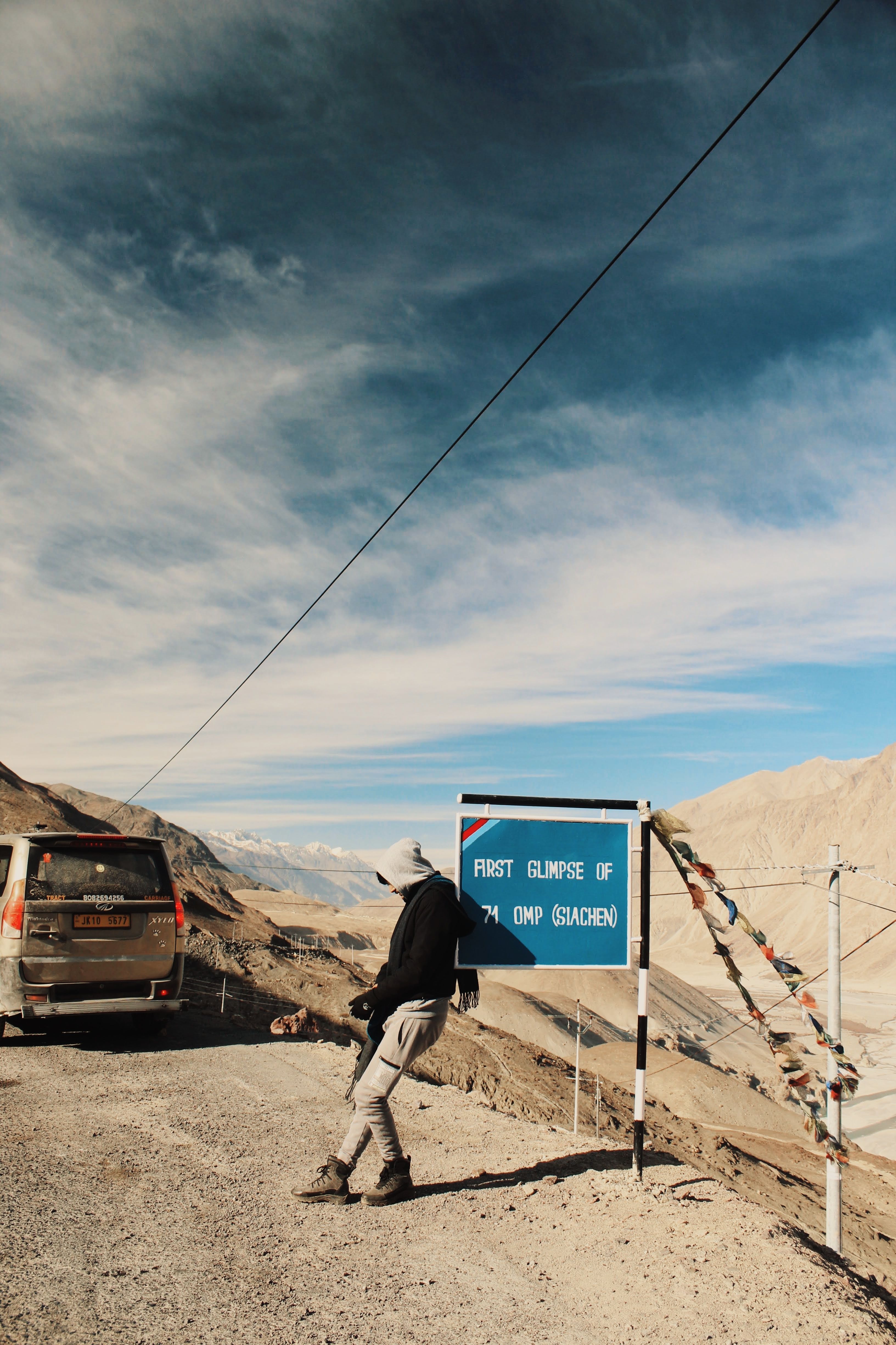 Tired Person Attempting to Hitch-hike on Desert Road · Free Stock Photo