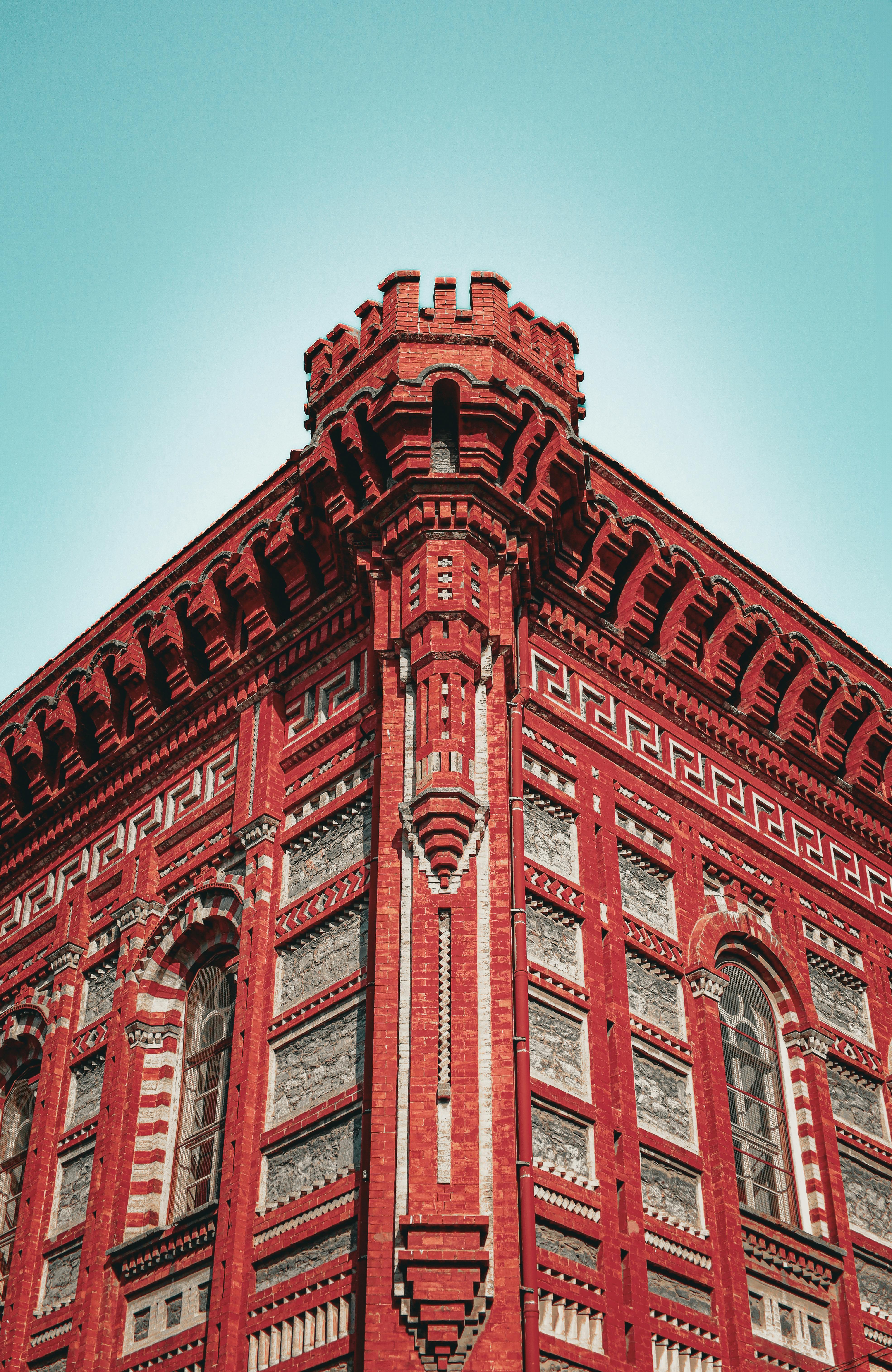 The red brick building has a clock tower · Free Stock Photo