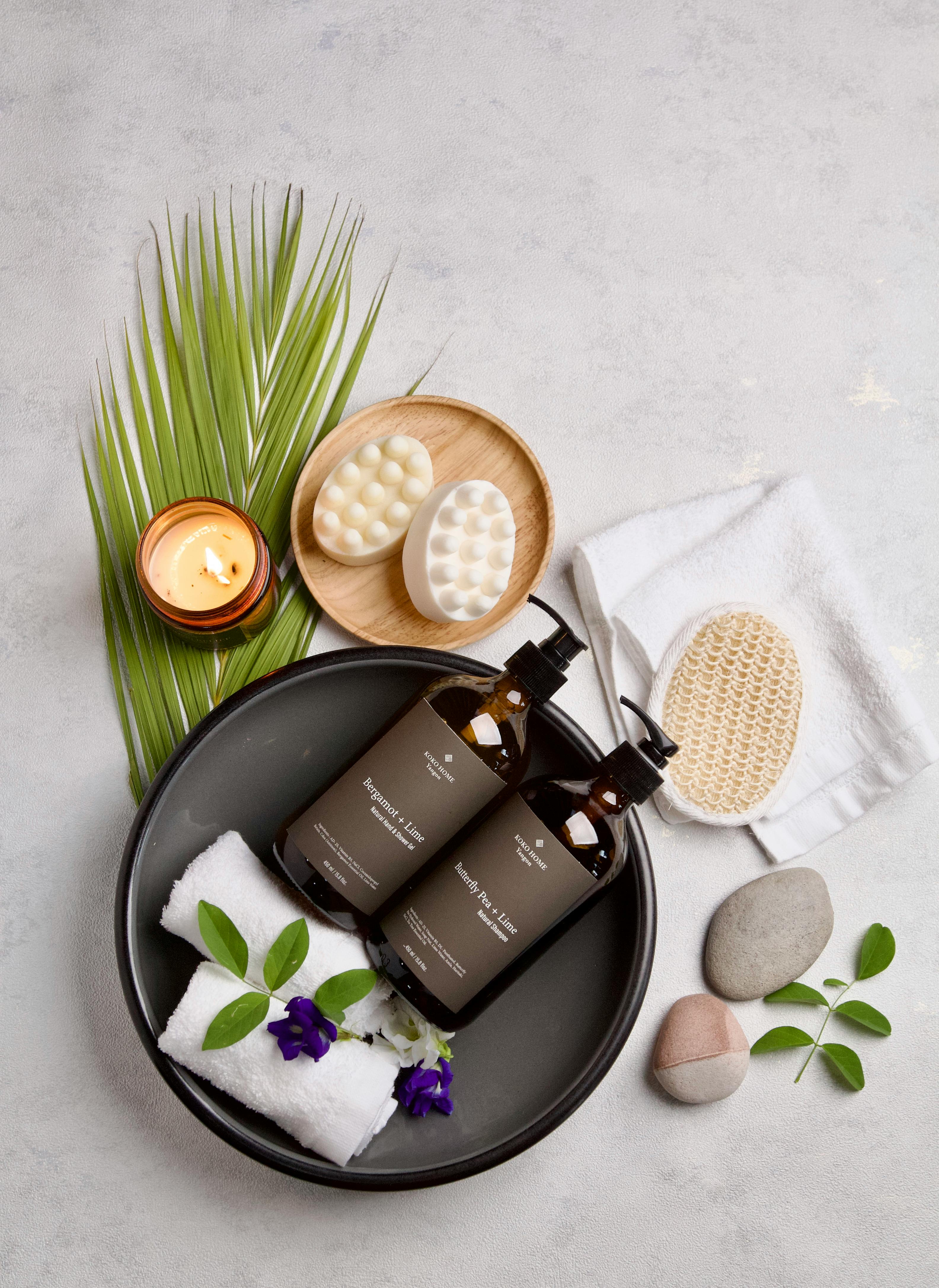 Shampoo Bottles Laid out on Plate with Towels and Skin Bristle · Free ...