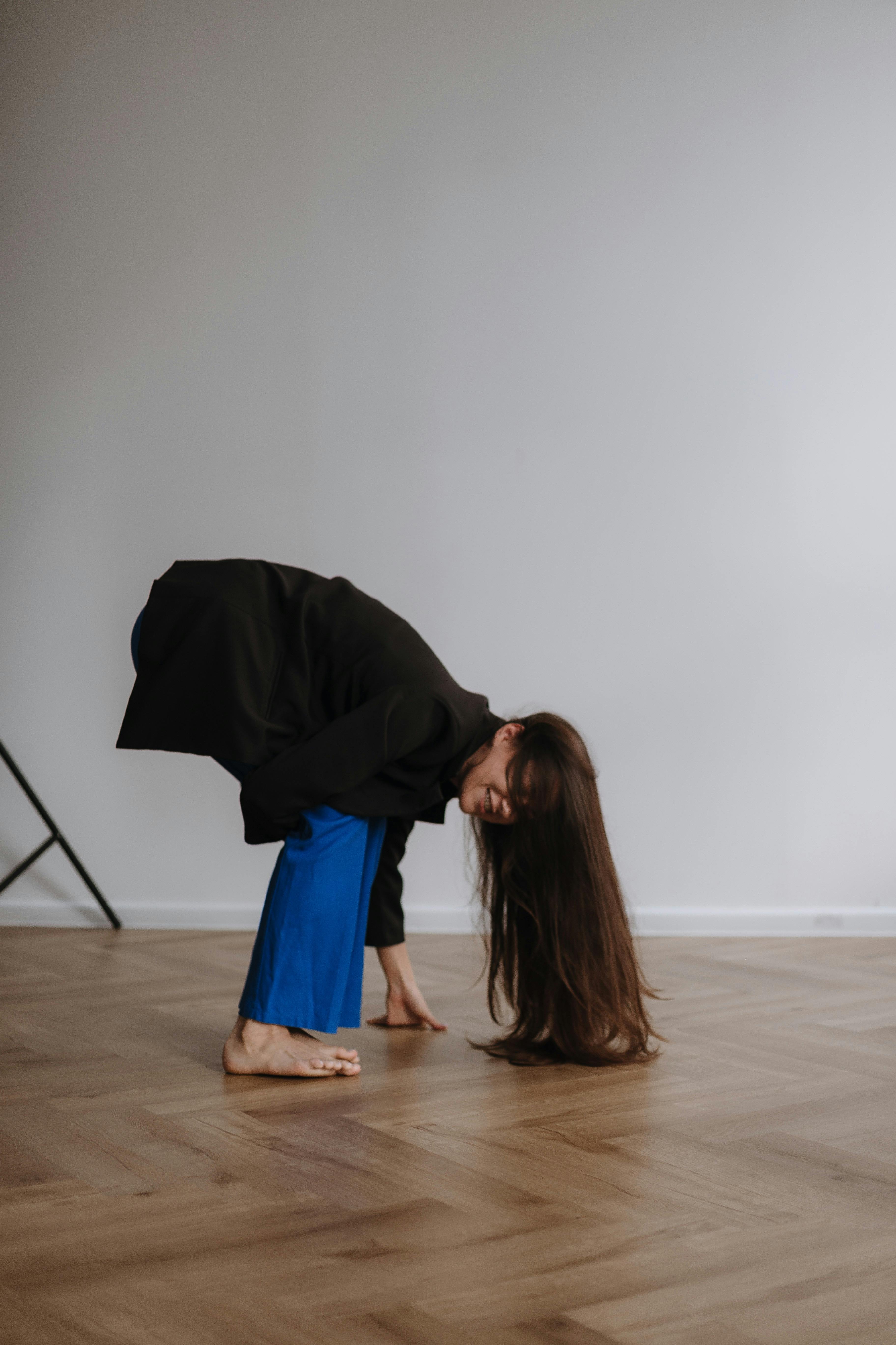 Woman Standing and Bending Forward · Free Stock Photo