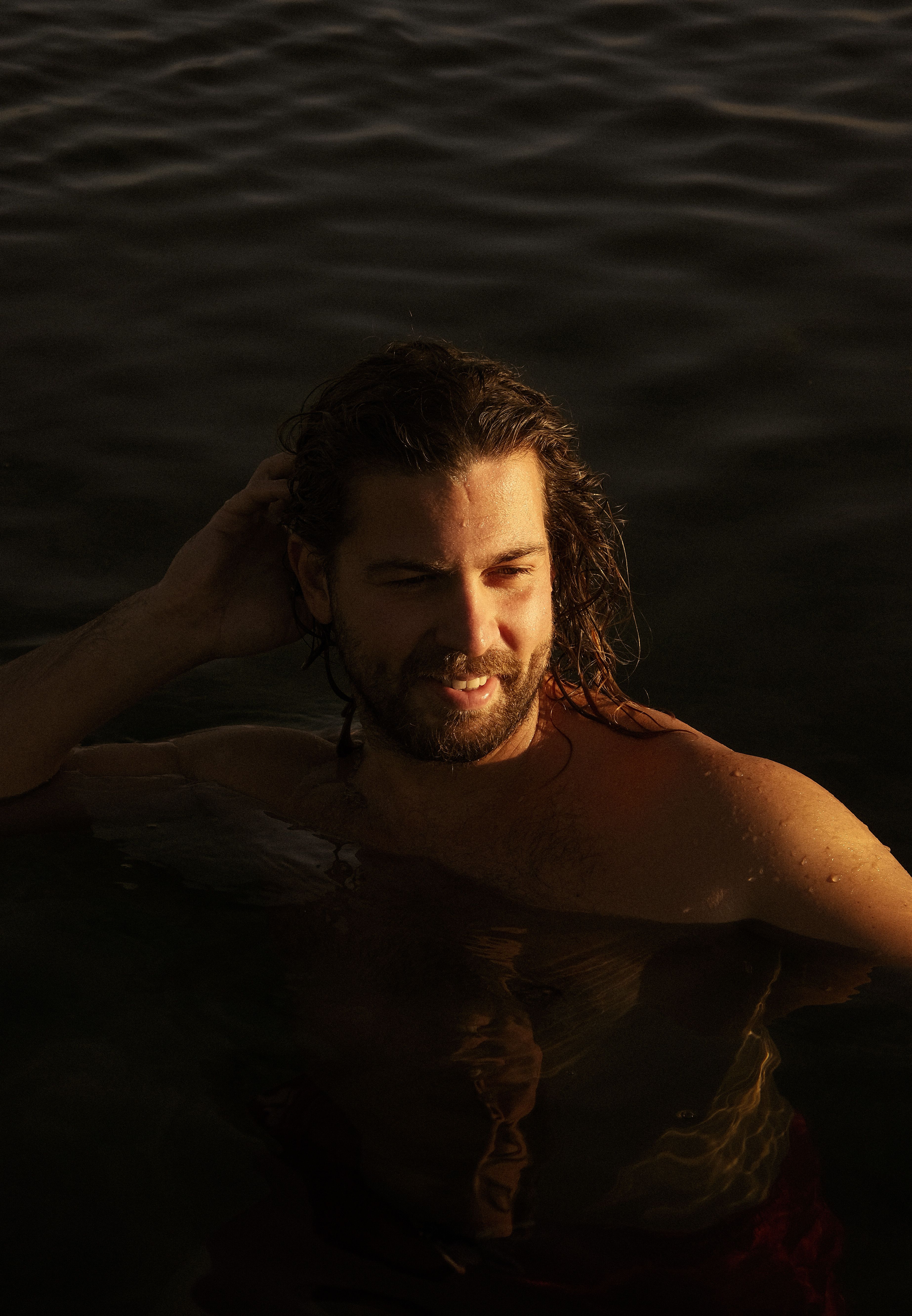 Smiling, Sunlit Man in Water · Free Stock Photo