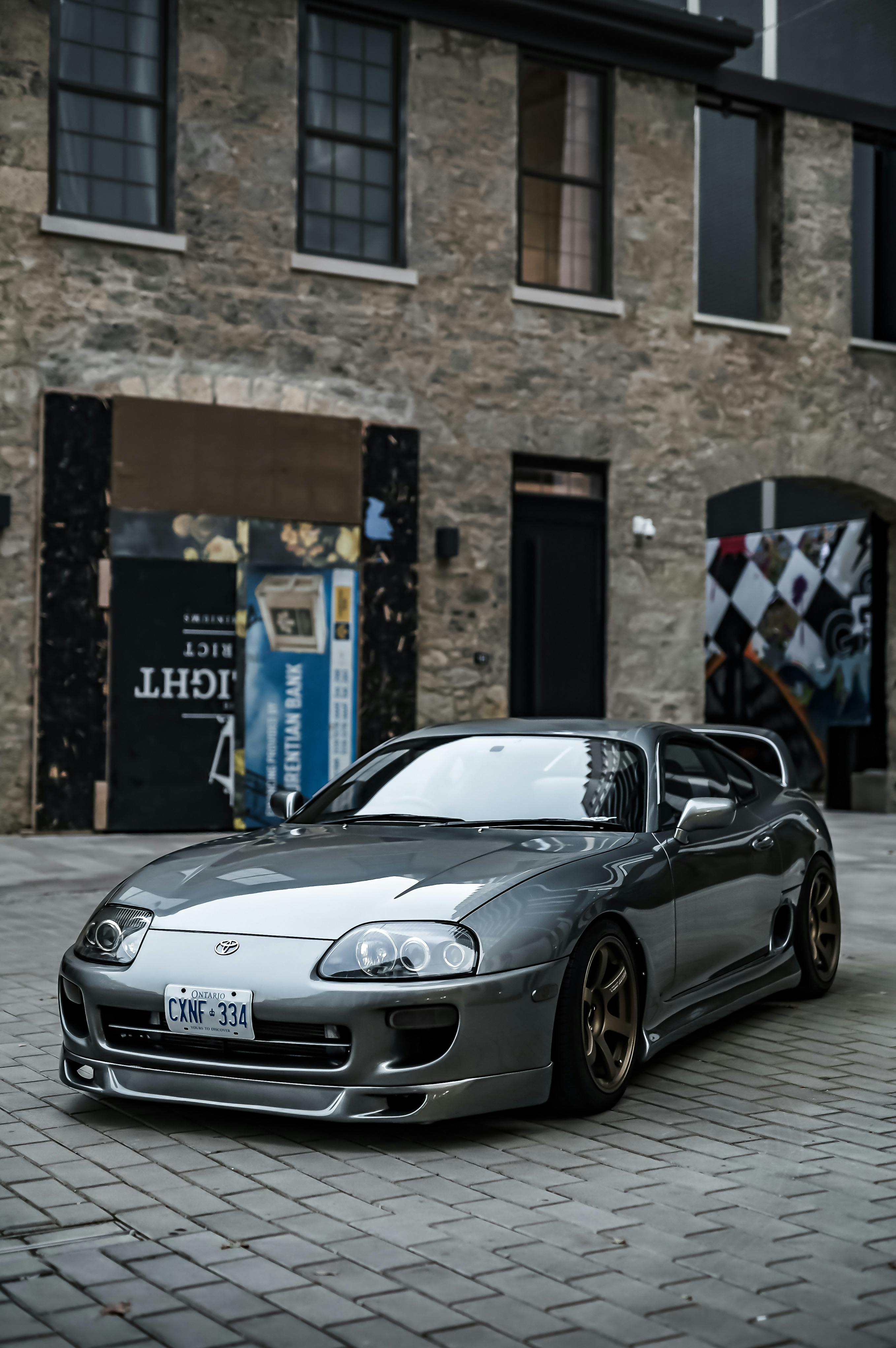 Silver Toyota Supra with Spoiler Parked under Building · Free Stock Photo