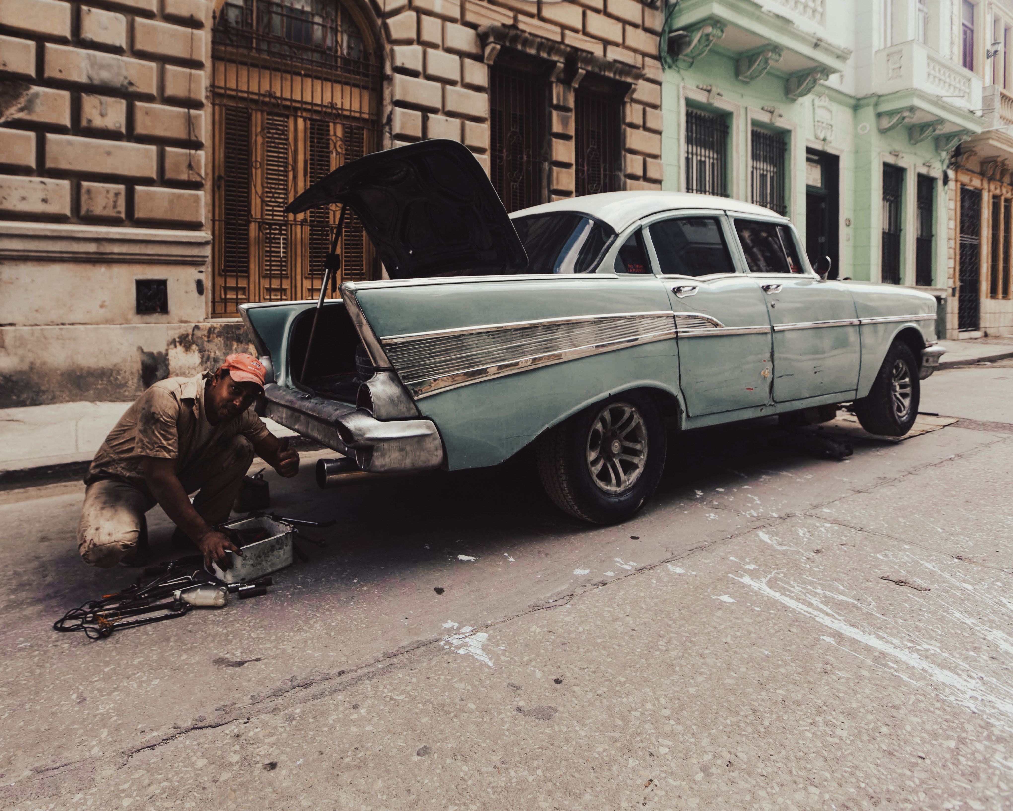 African Man Fixing Vintage Car · Free Stock Photo
