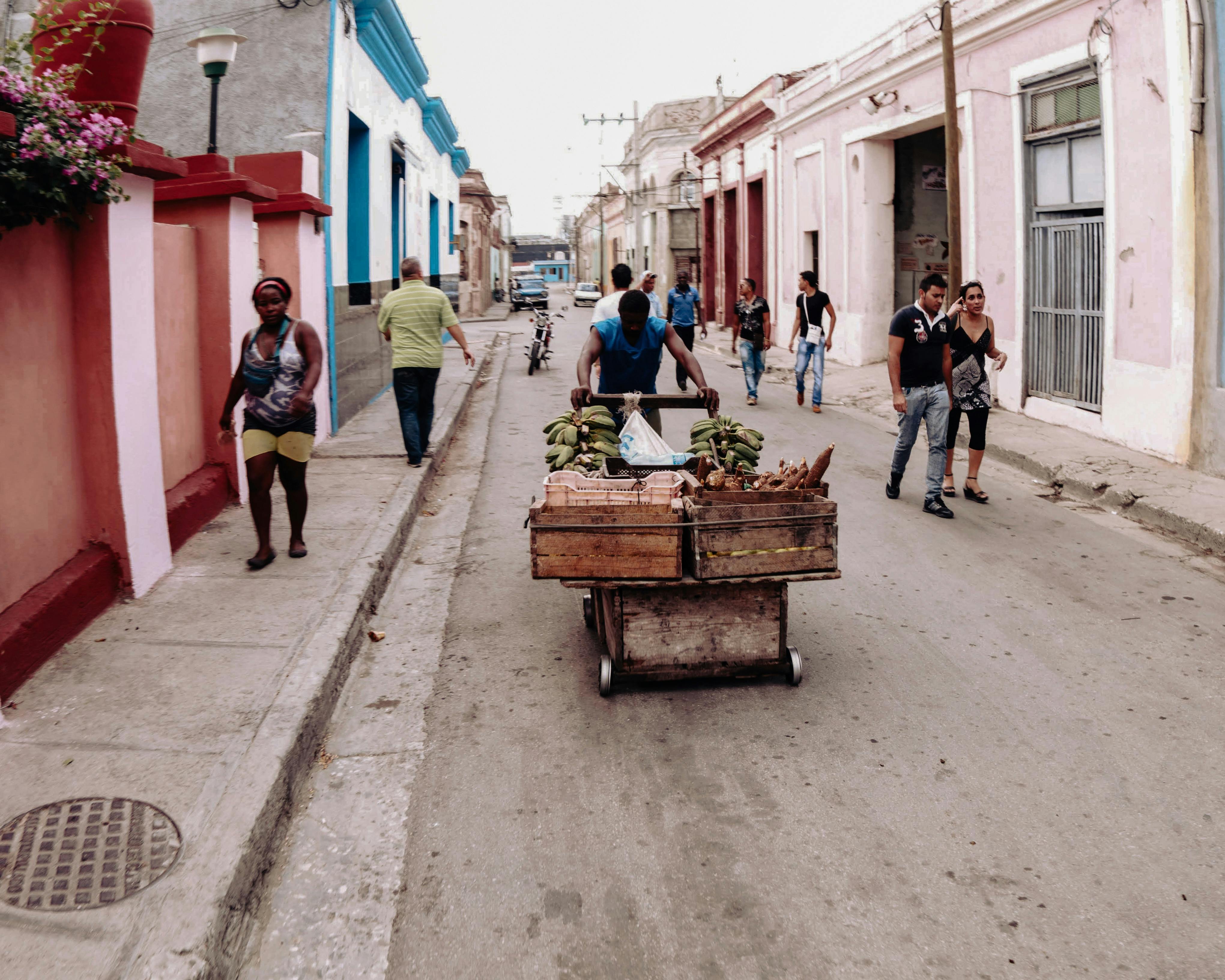 Man Pushing Cart with Merchandise · Free Stock Photo