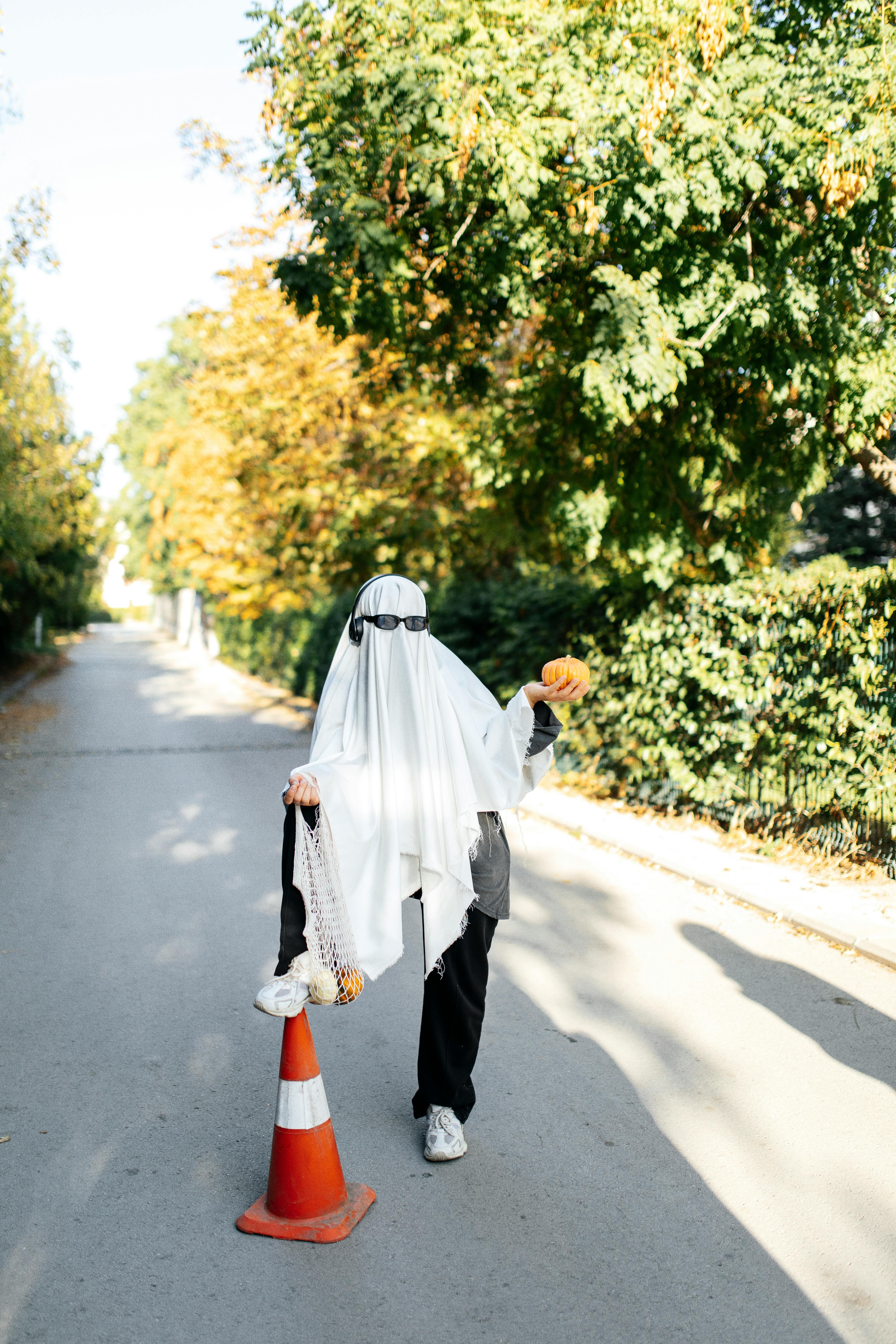 Ghost Posing in Sunglasses and Headphones on Street · Free Stock Photo