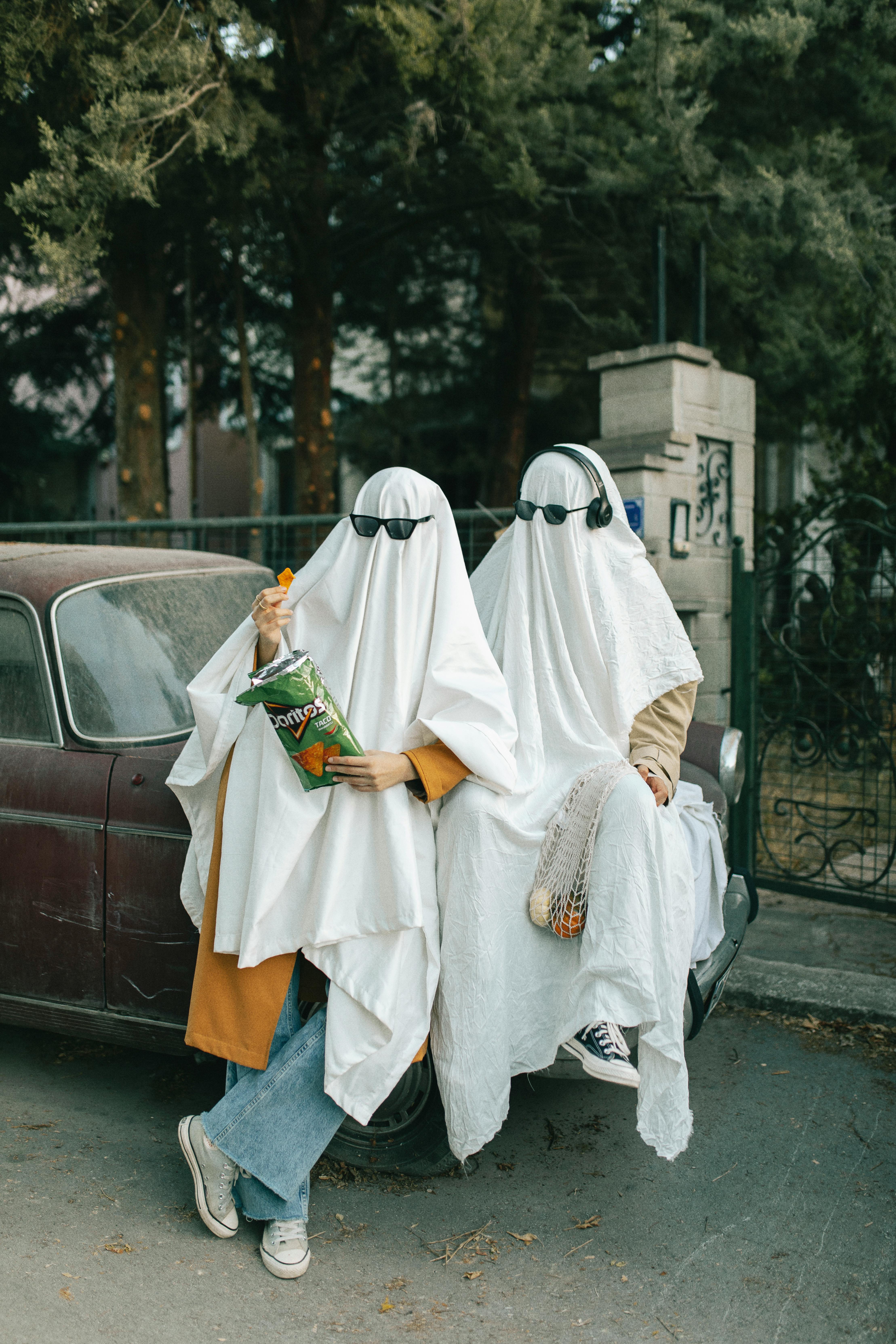 Ghosts Eating Doritos on the Hood of a Haunted Car · Free Stock Photo