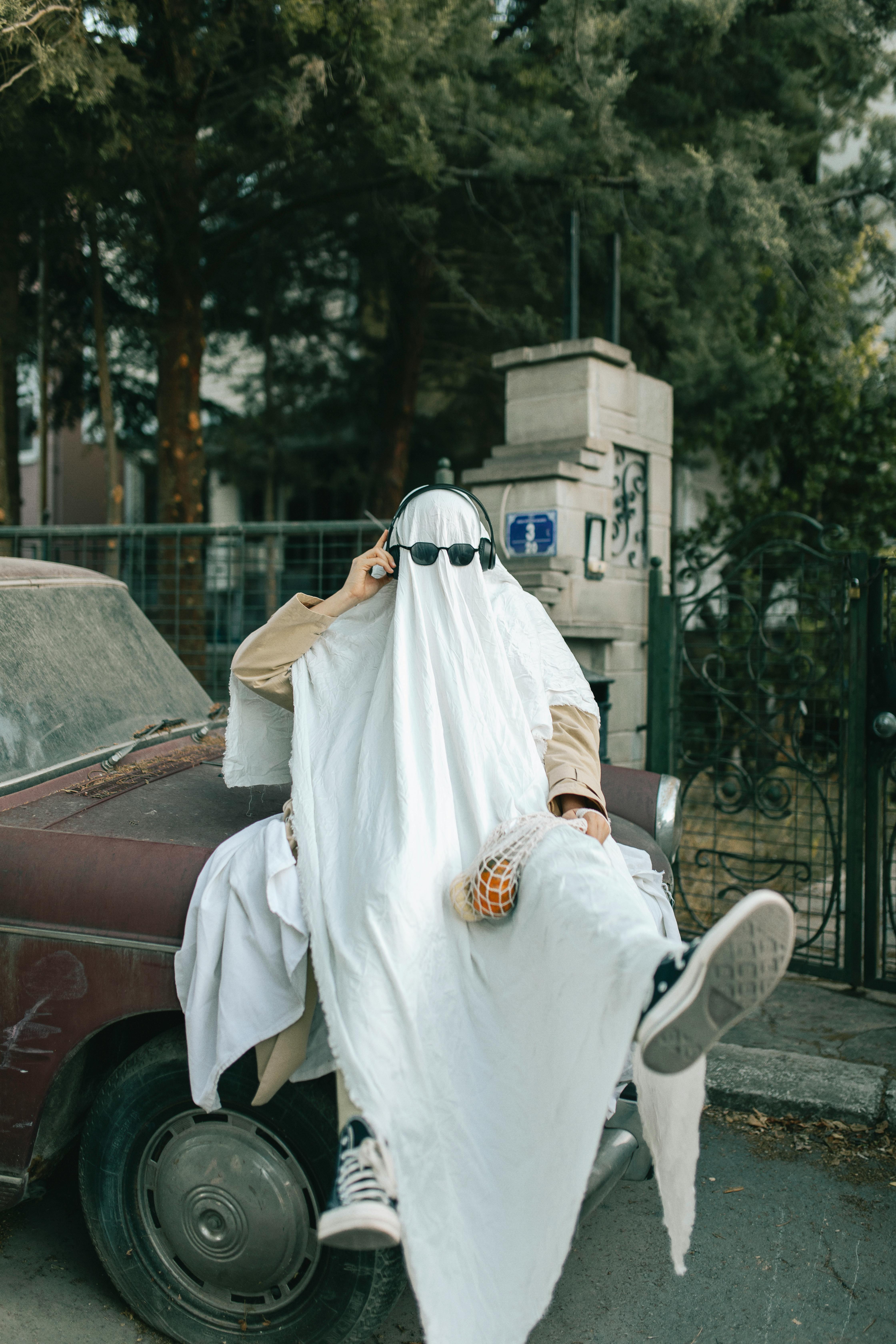 Ghost in Sunglasses Listening to Music in Headphones While Sitting on ...