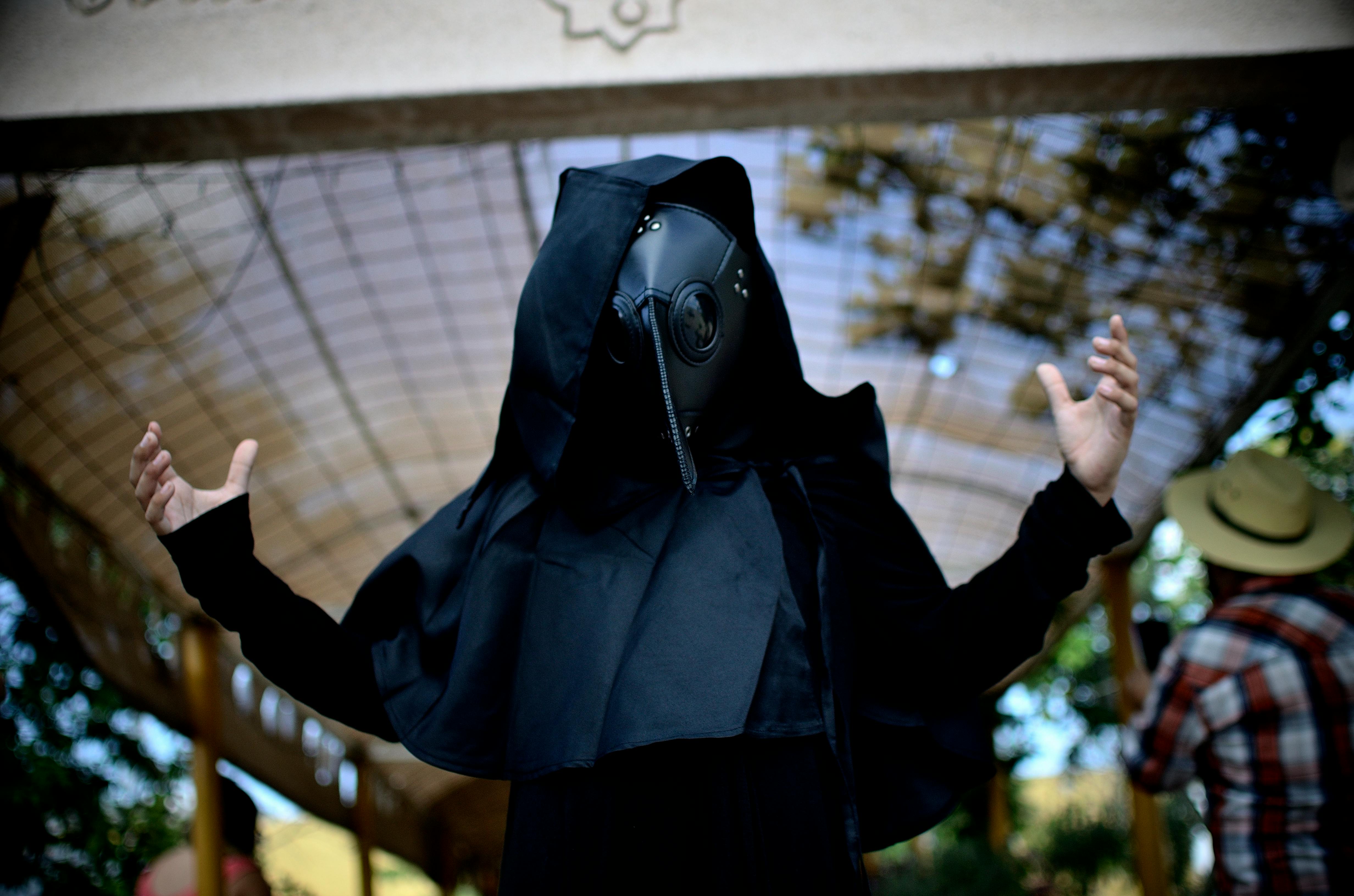 Man in a Dark Anonymous Costume · Free Stock Photo