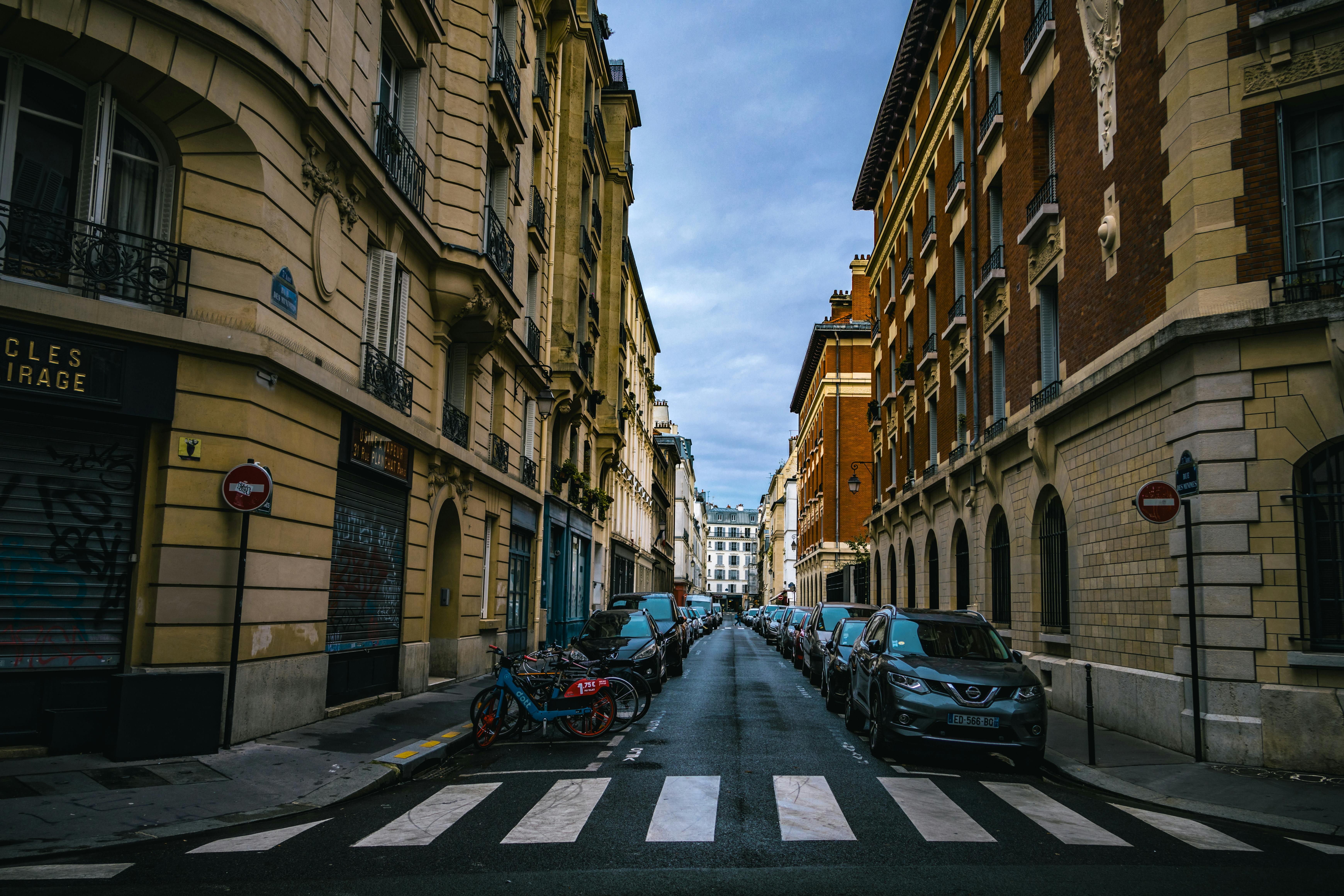 Crossing City Street with Old Buildings · Free Stock Photo