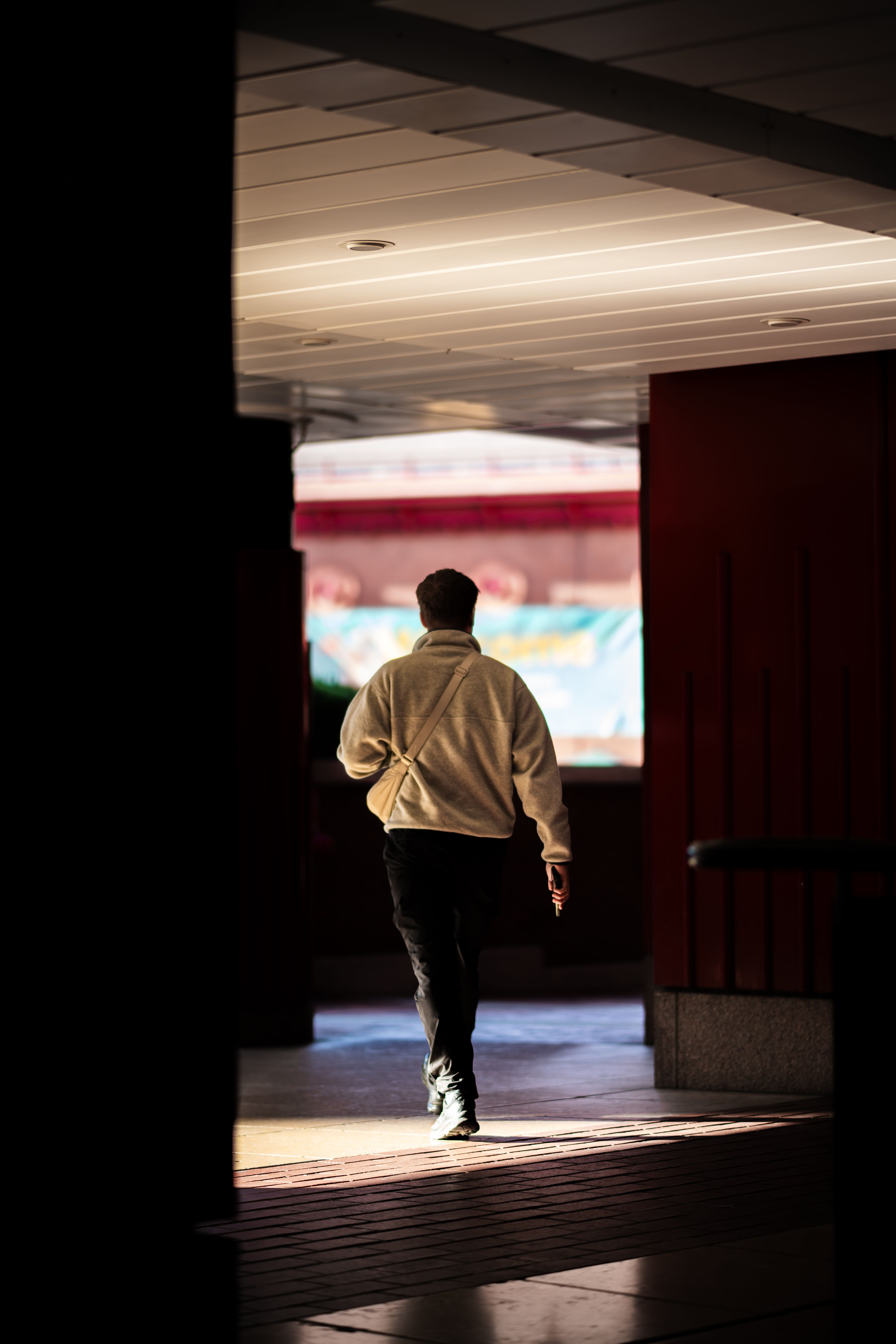 A Man Walking in a Building · Free Stock Photo