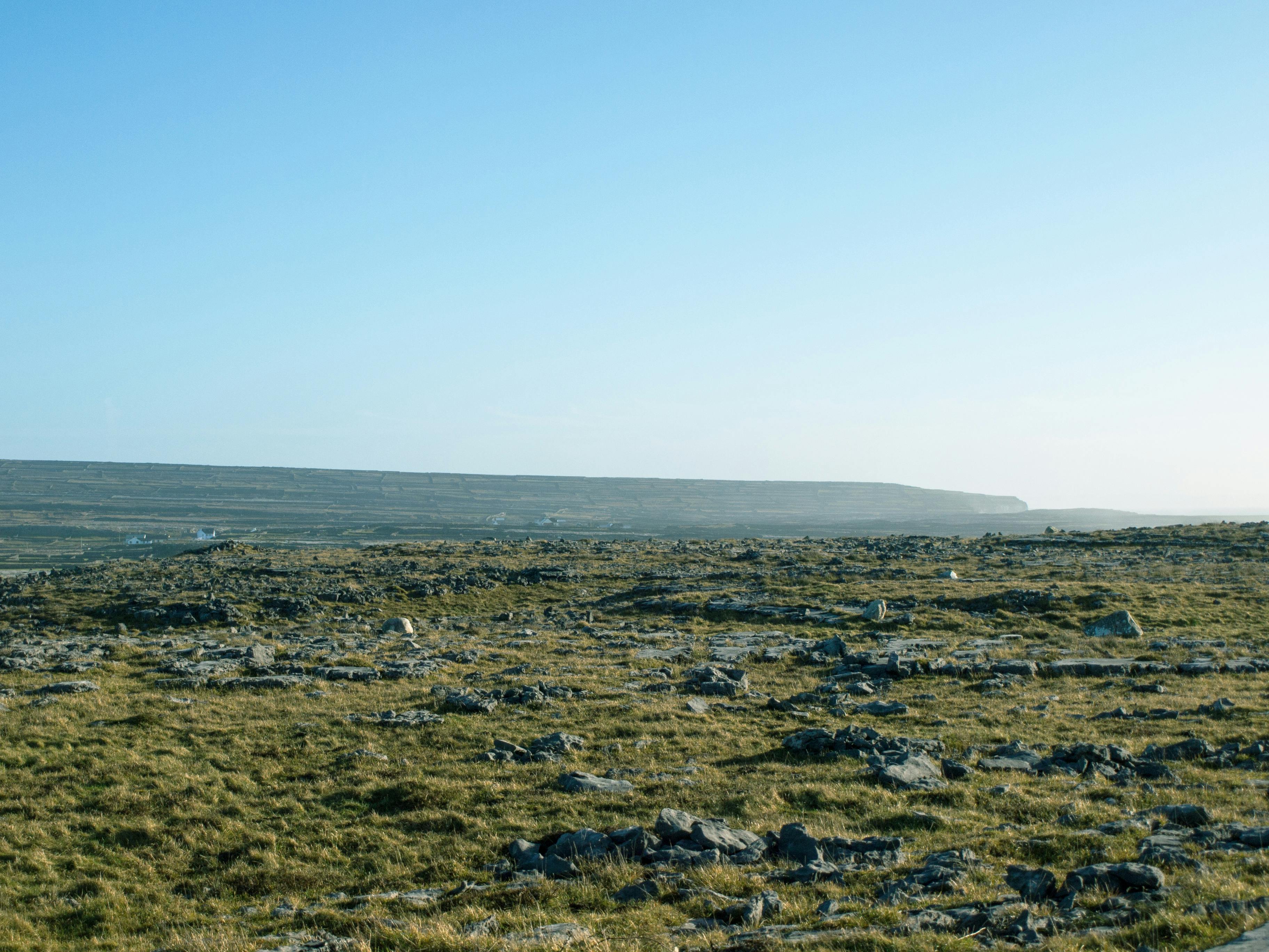 A large open field with rocks and grass · Free Stock Photo