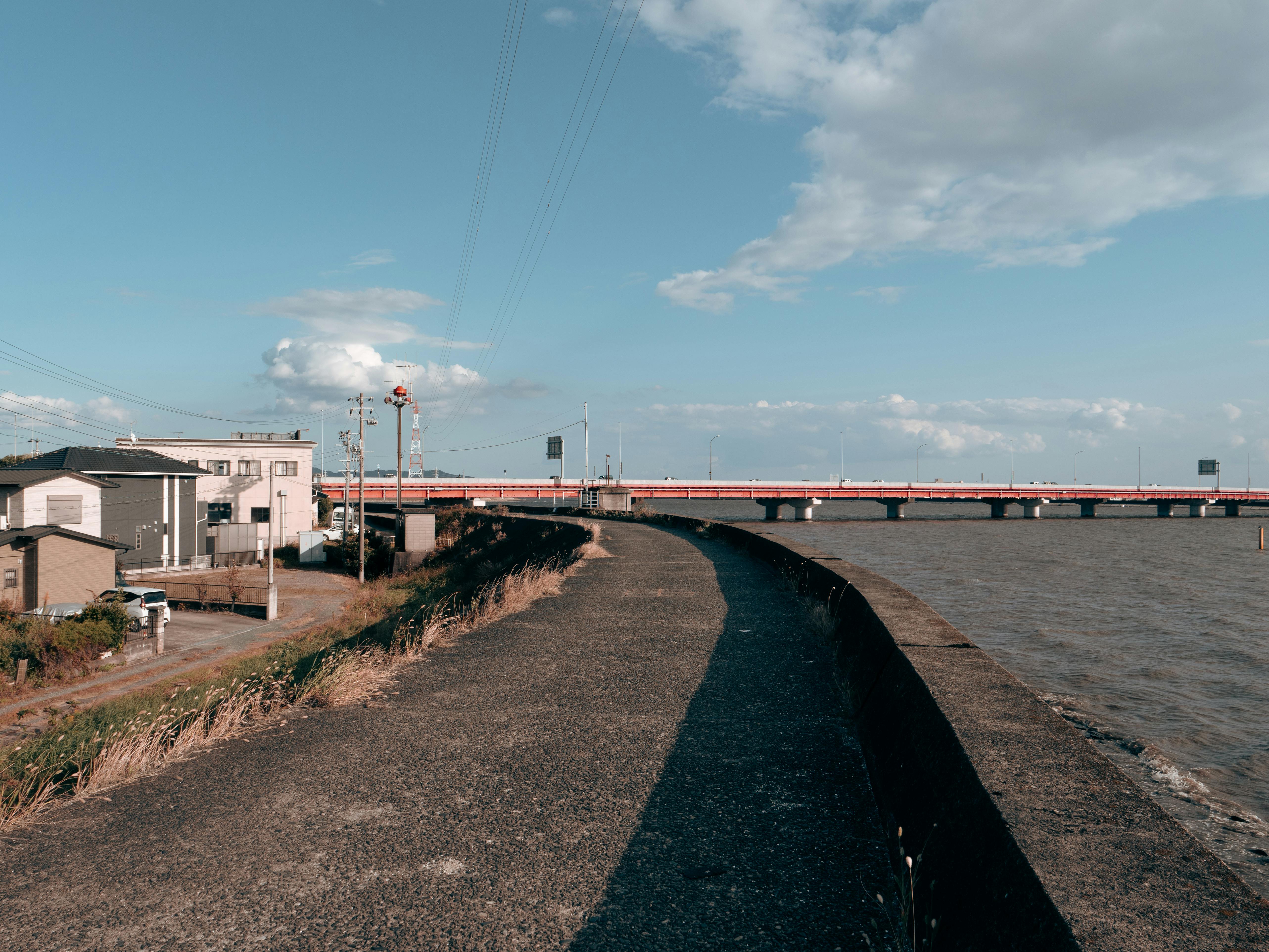 Promenade Along the Seashore Towards the Bridge · Free Stock Photo