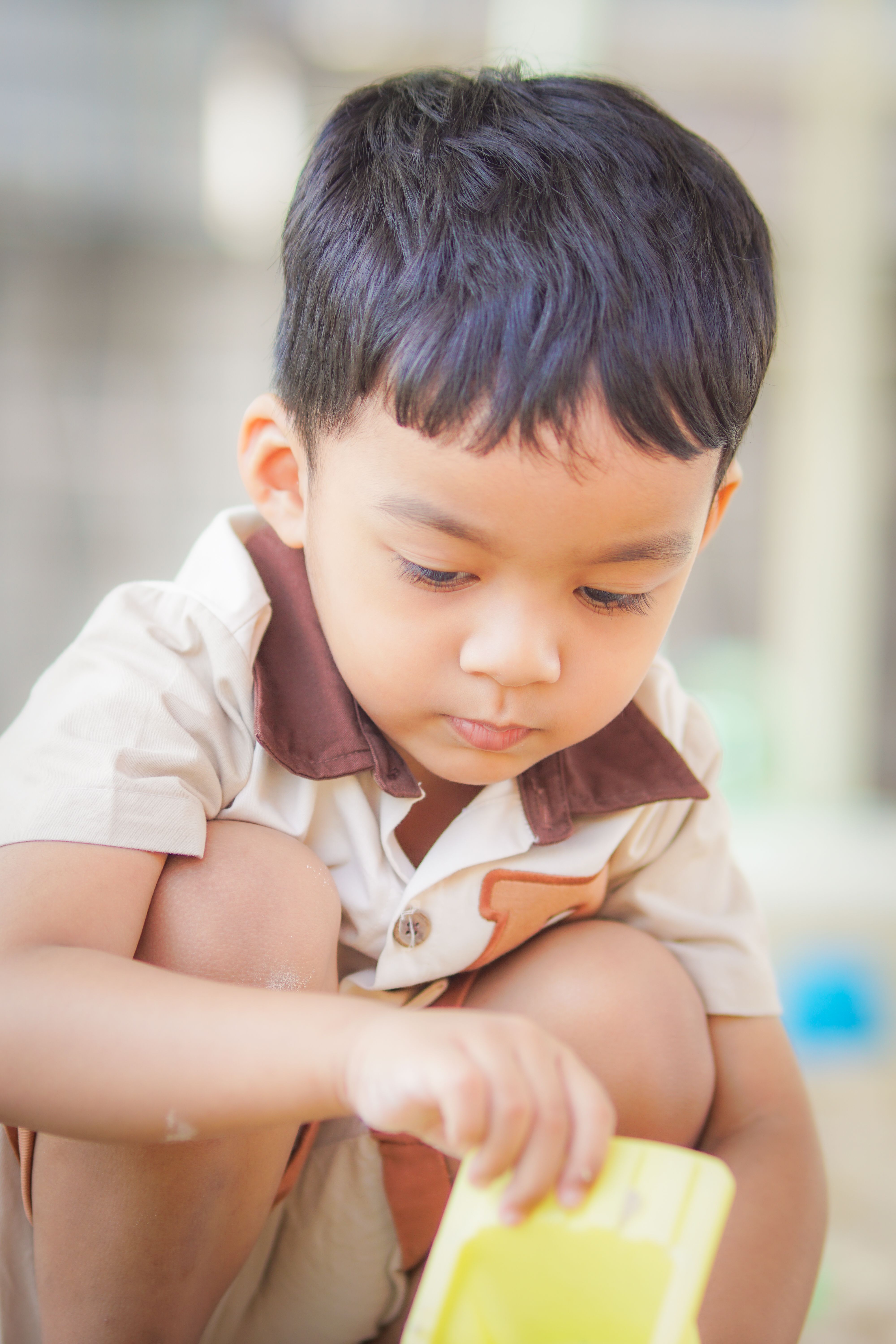 Boy Holding a Plastic Toy · Free Stock Photo