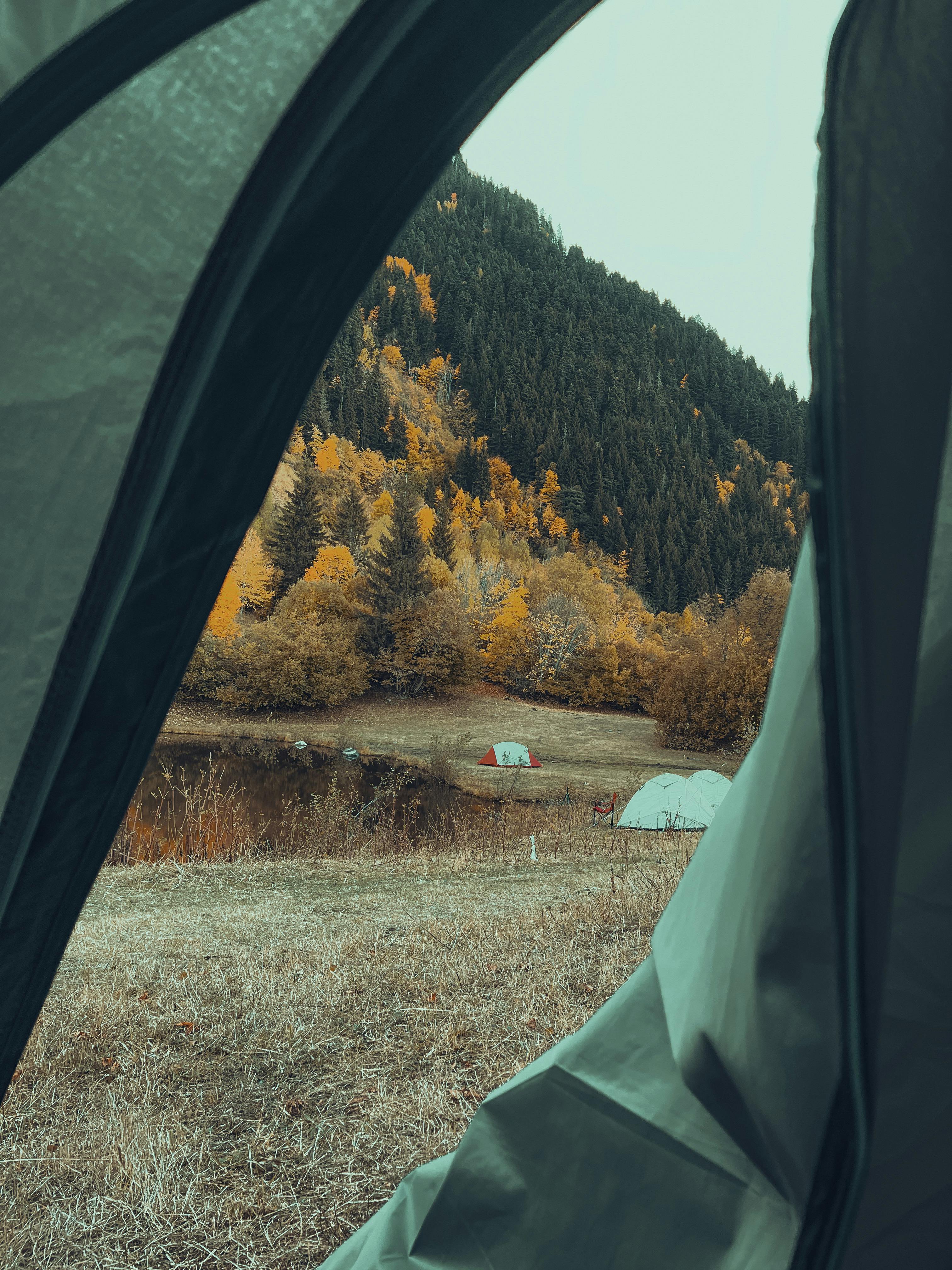Tents on Camping under Hill with Forest in Autumn · Free Stock Photo