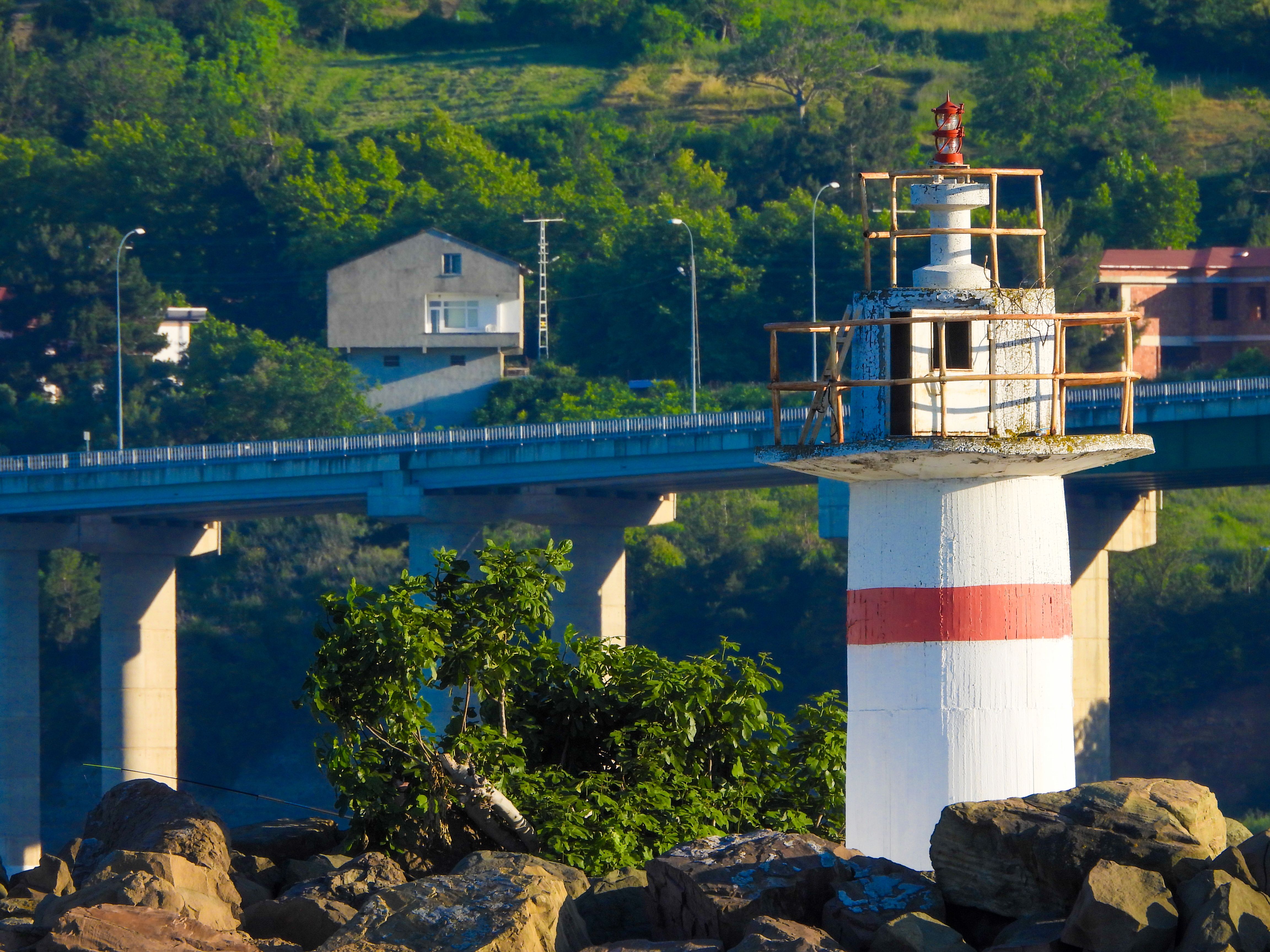 Lighthouse with a Bridge in the Background · Free Stock Photo