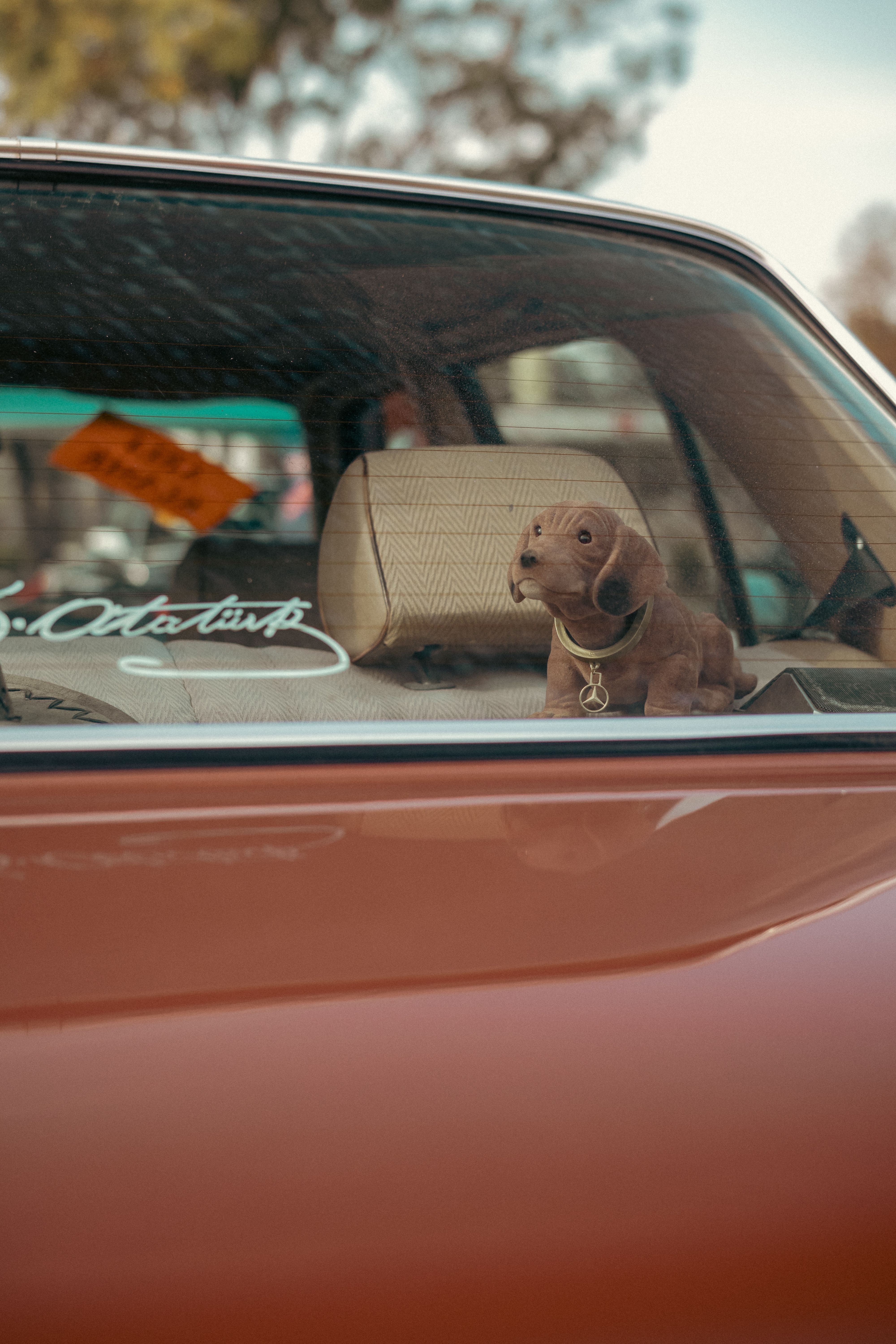 Figurine of a Dog with the Mercedes Logo on its Collar Behind the Back ...
