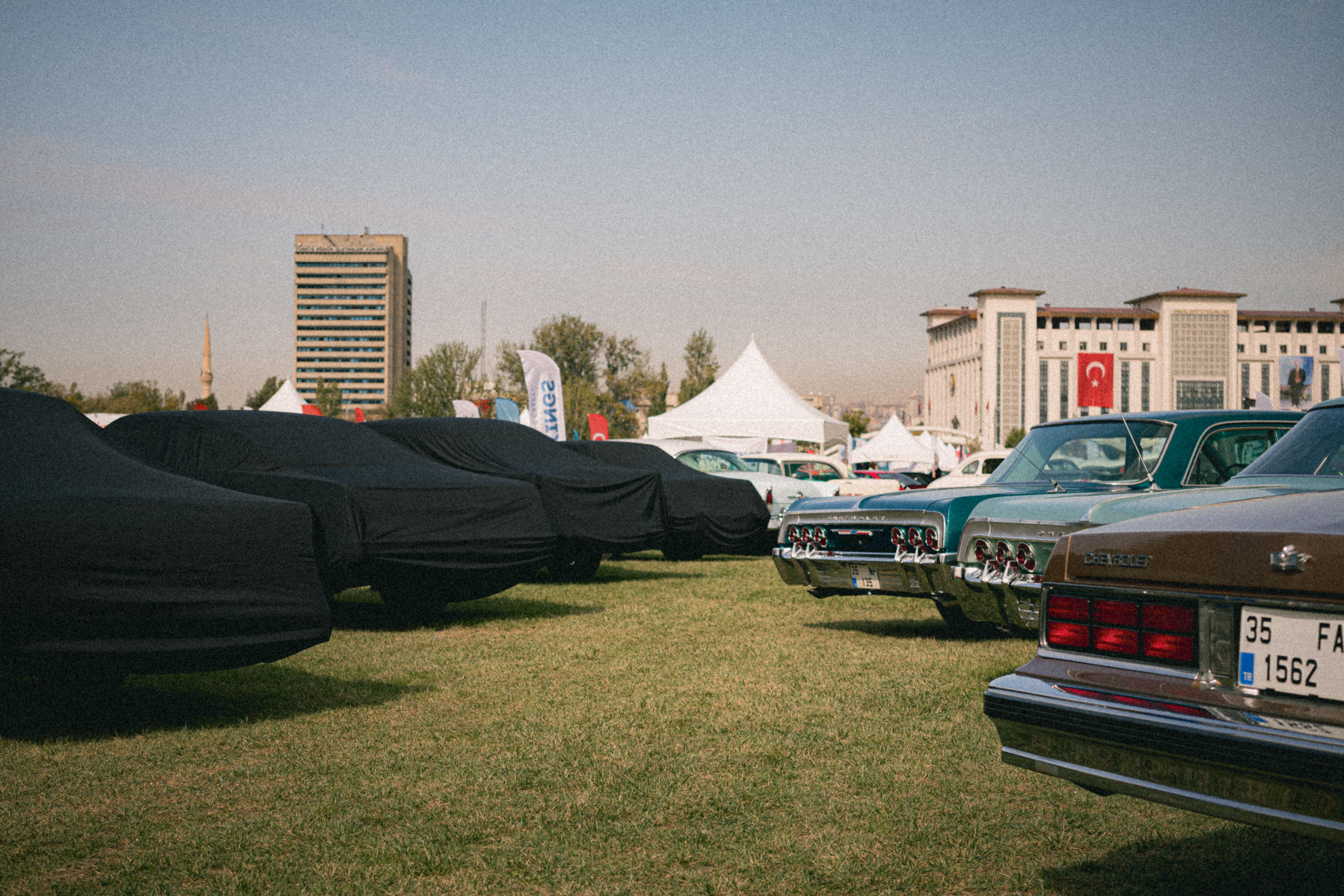 Row of Covered Classic Cars at a Car Show Next to Old Chevrolets · Free ...