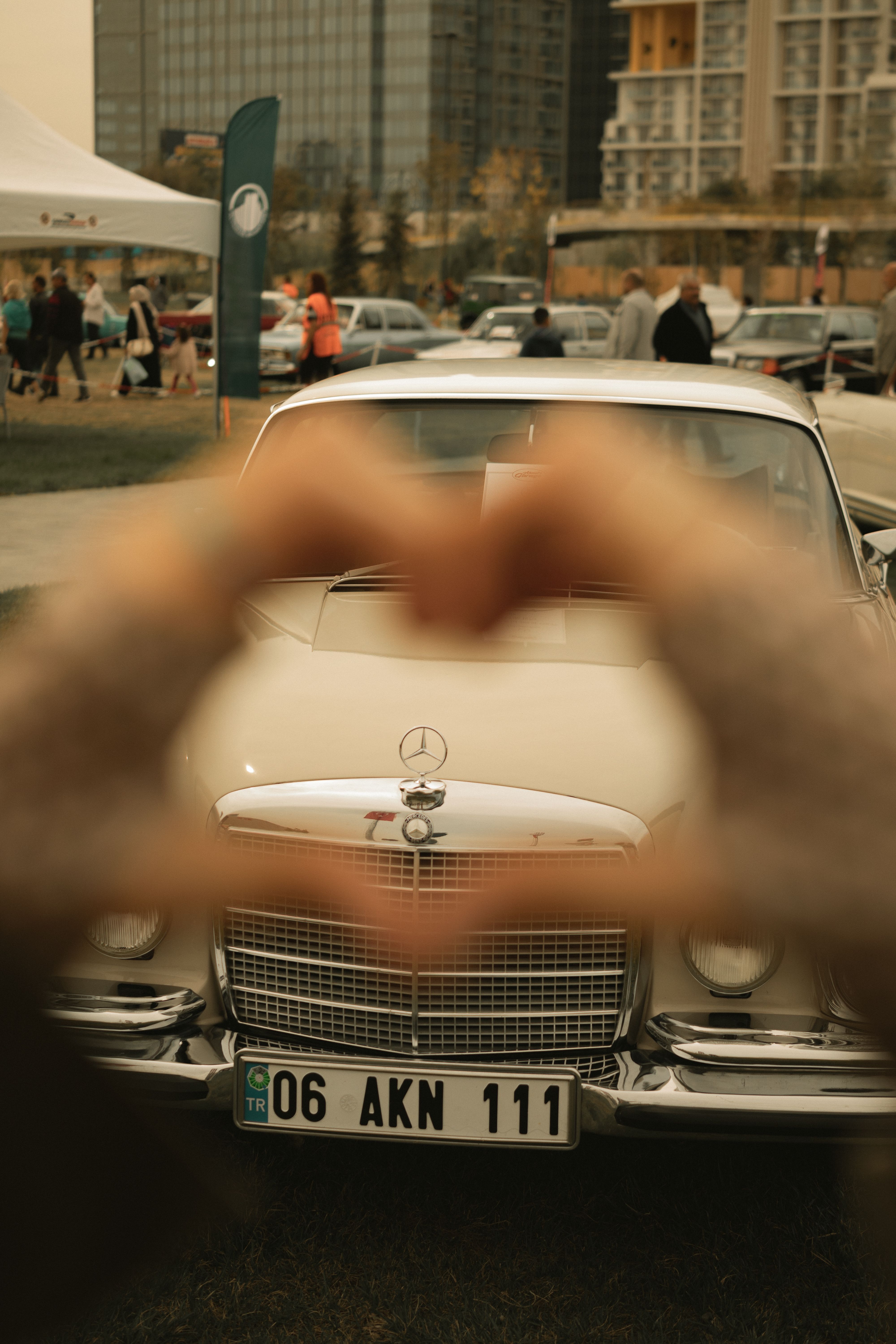 Hand Heart in Front of Mercedes W115 at a Car Show · Free Stock Photo