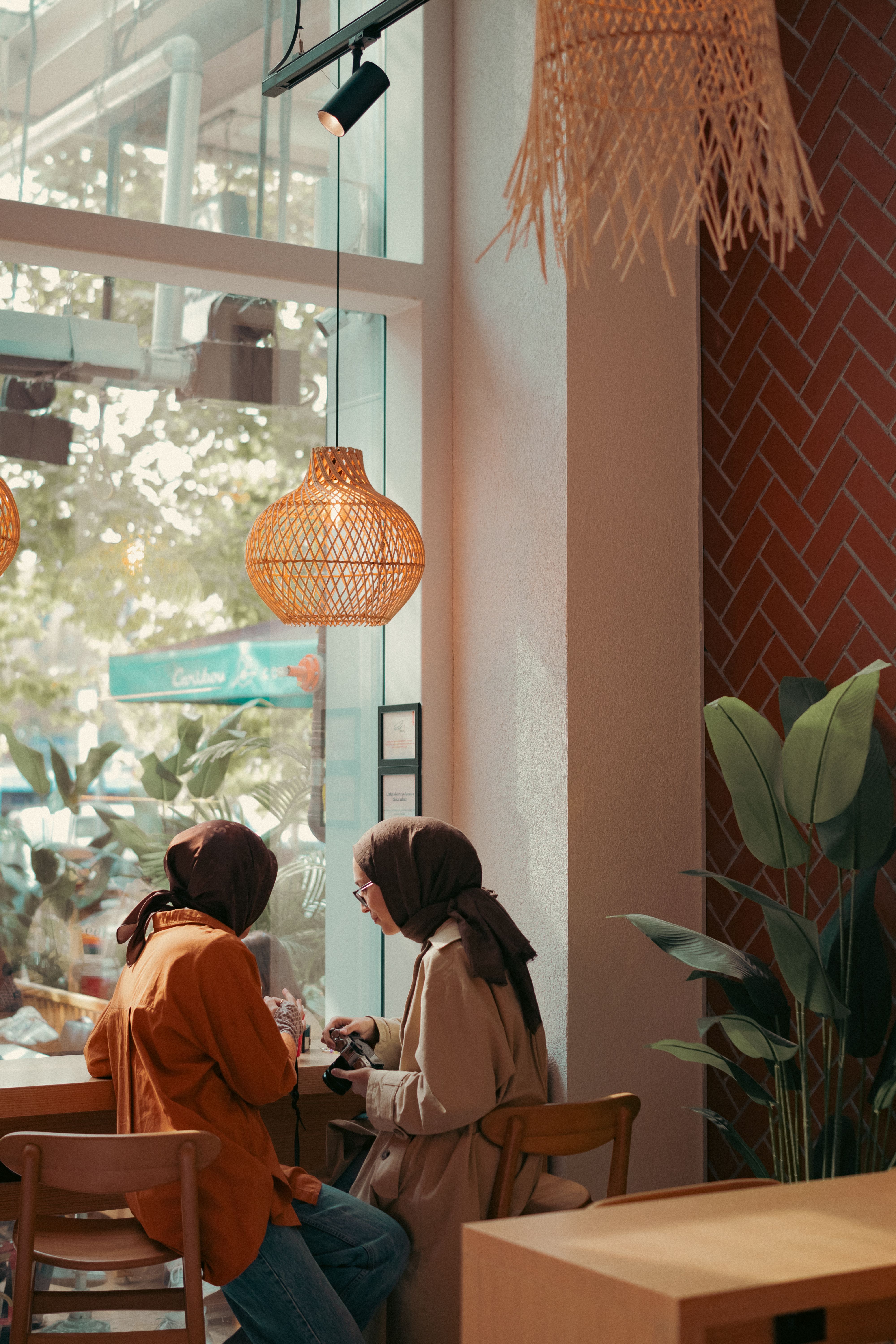 Two Women Sitting at the Table in a Cafe · Free Stock Photo