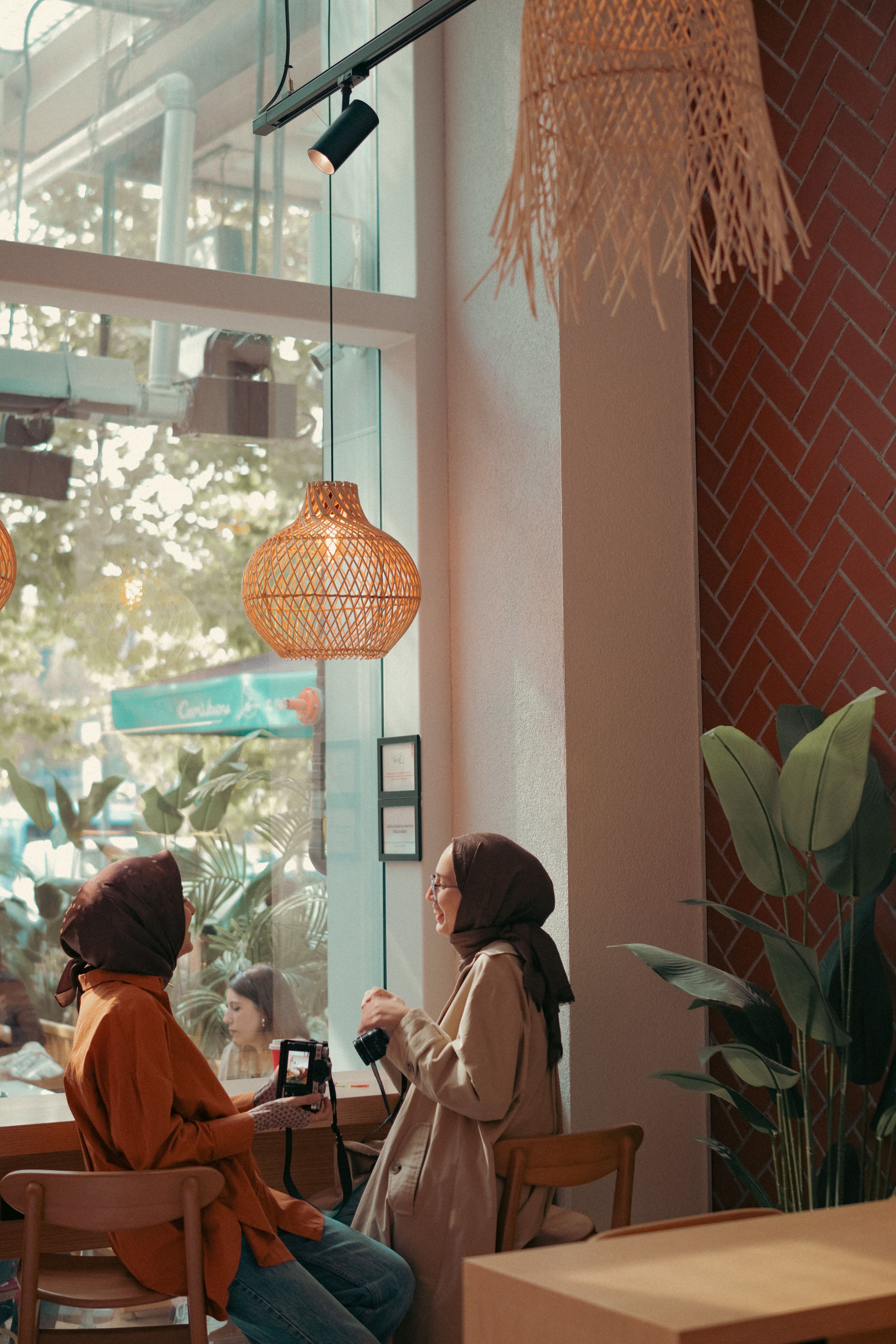 Two Women Sitting at the Table in a Cafe · Free Stock Photo